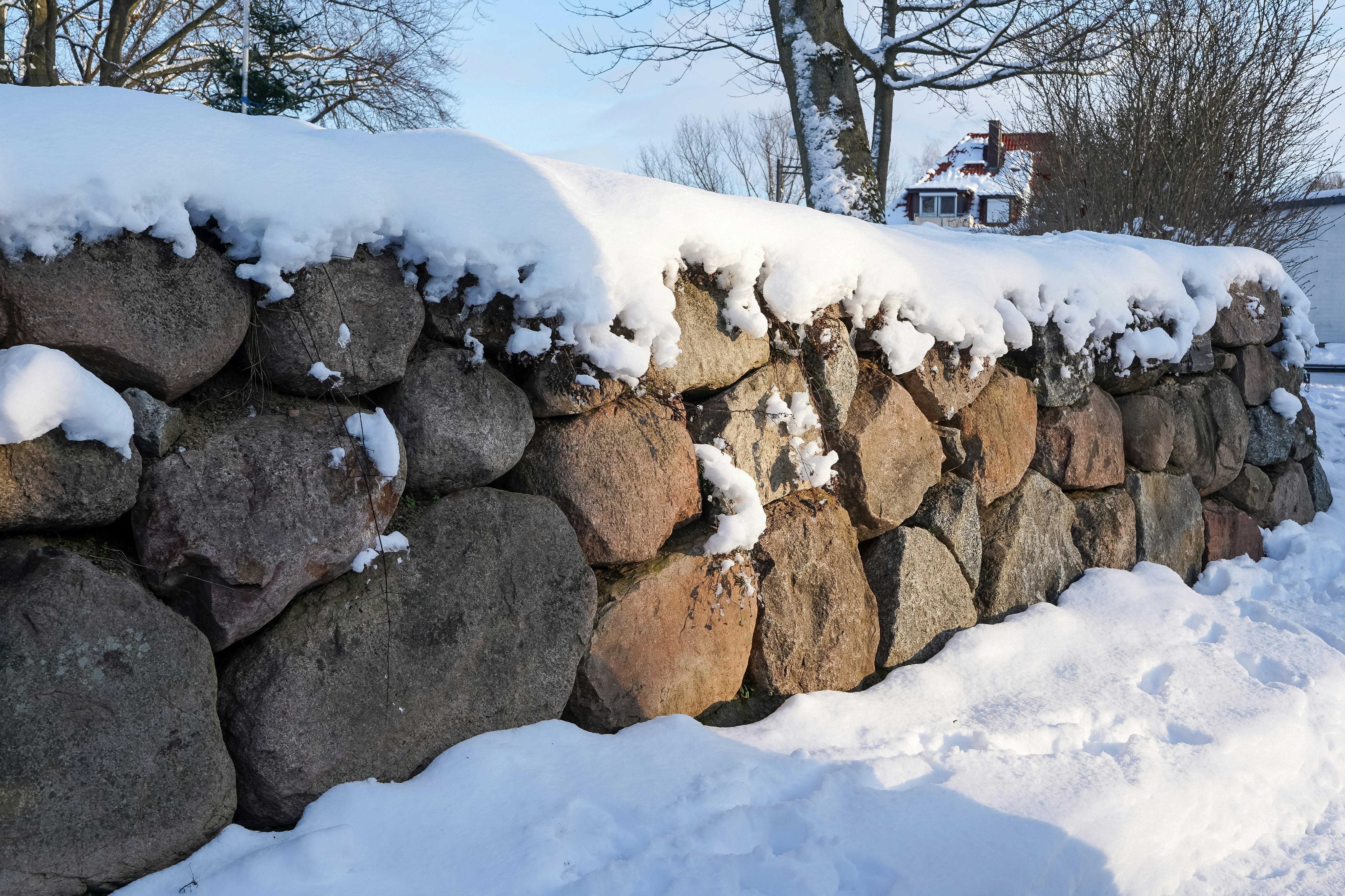 Snow-lit Stone Wall with Distant House Tops