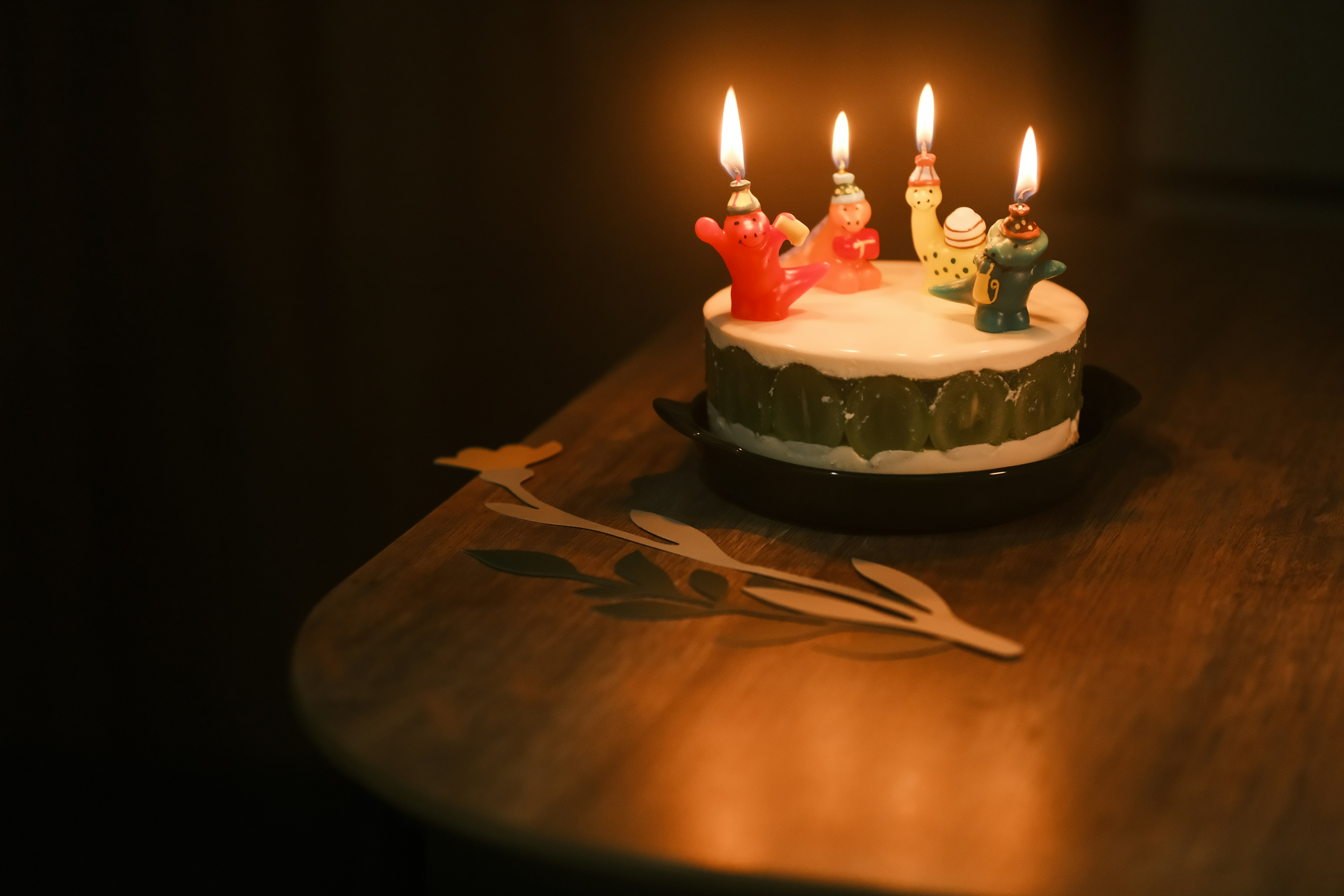 Candlelit Birthday Cake on a Rustic Table