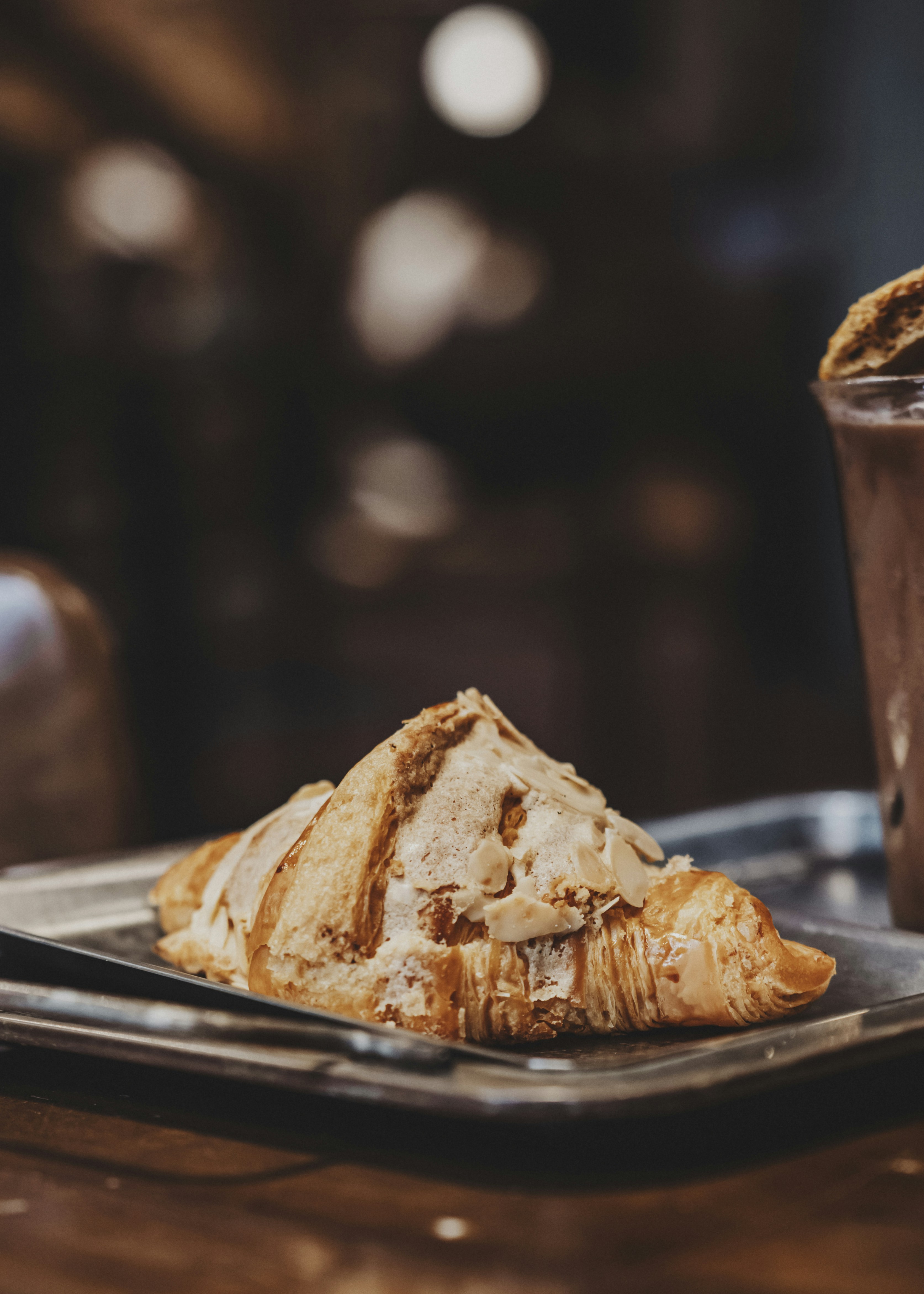 Crisp Danish Pastry on a Rustic Plate under Warm Café Lighting