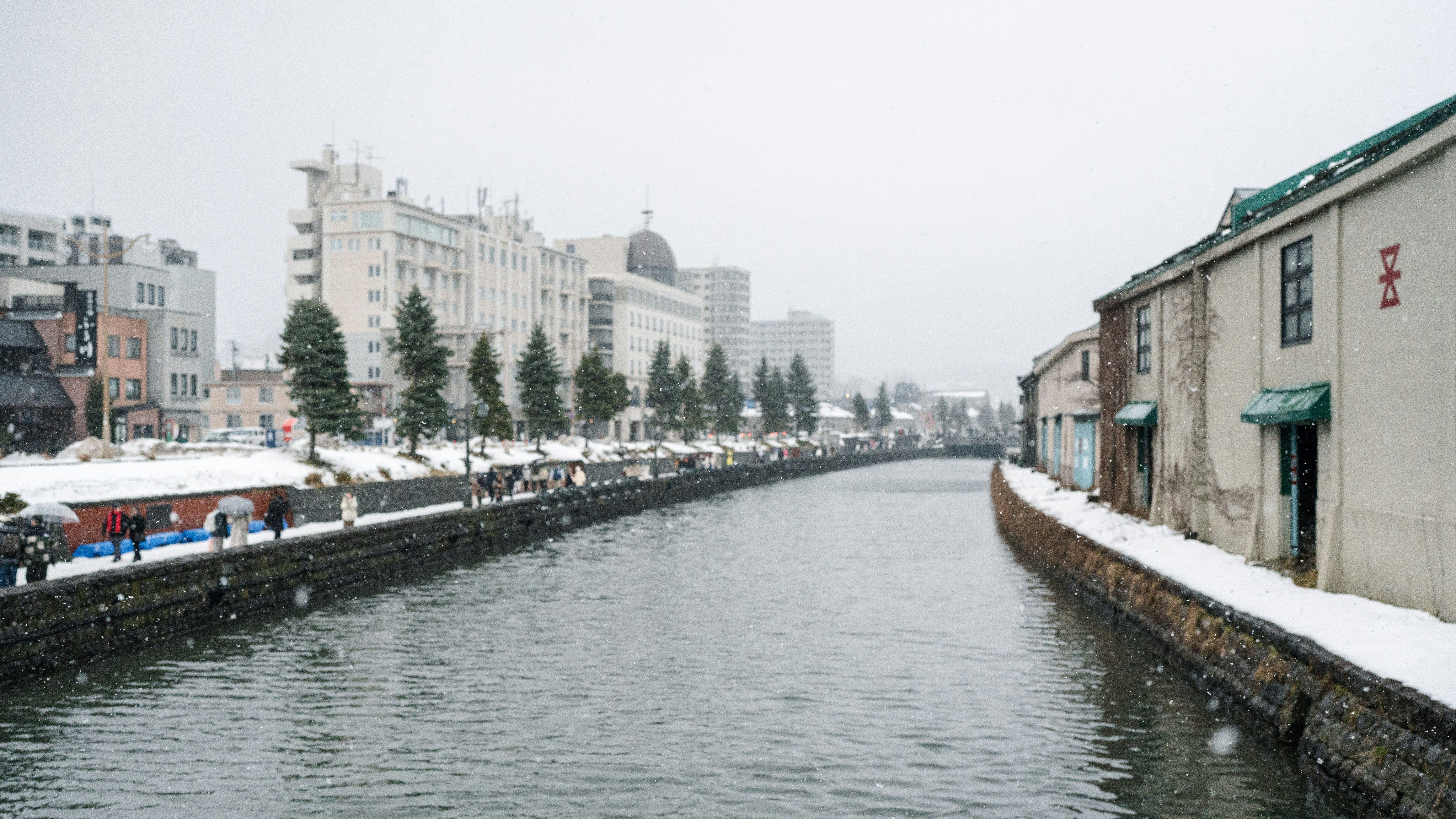 Snowy Canal Promenade Under a Grey Winter Sky