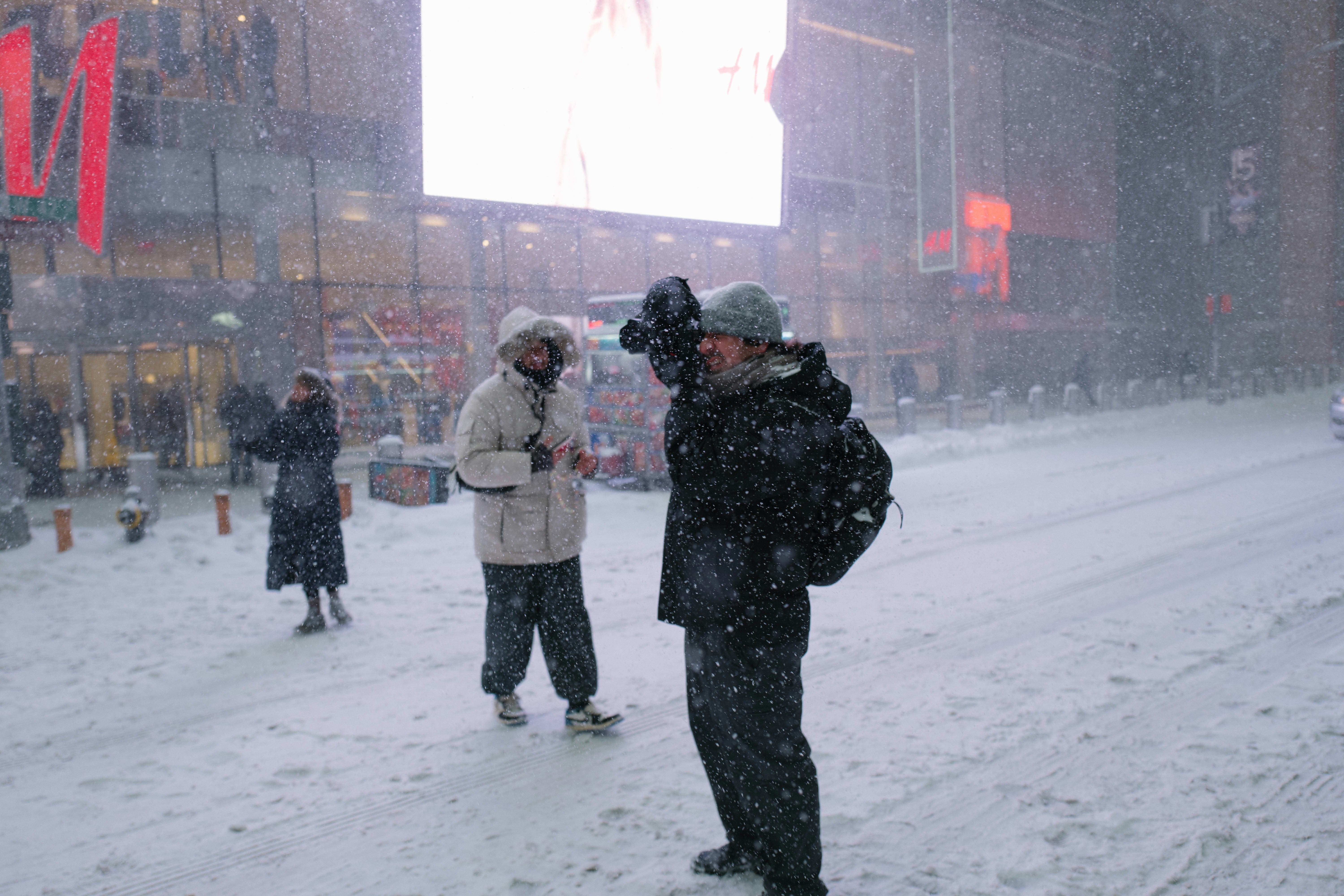 Snowbound Pause in a Neon-Soaked Square