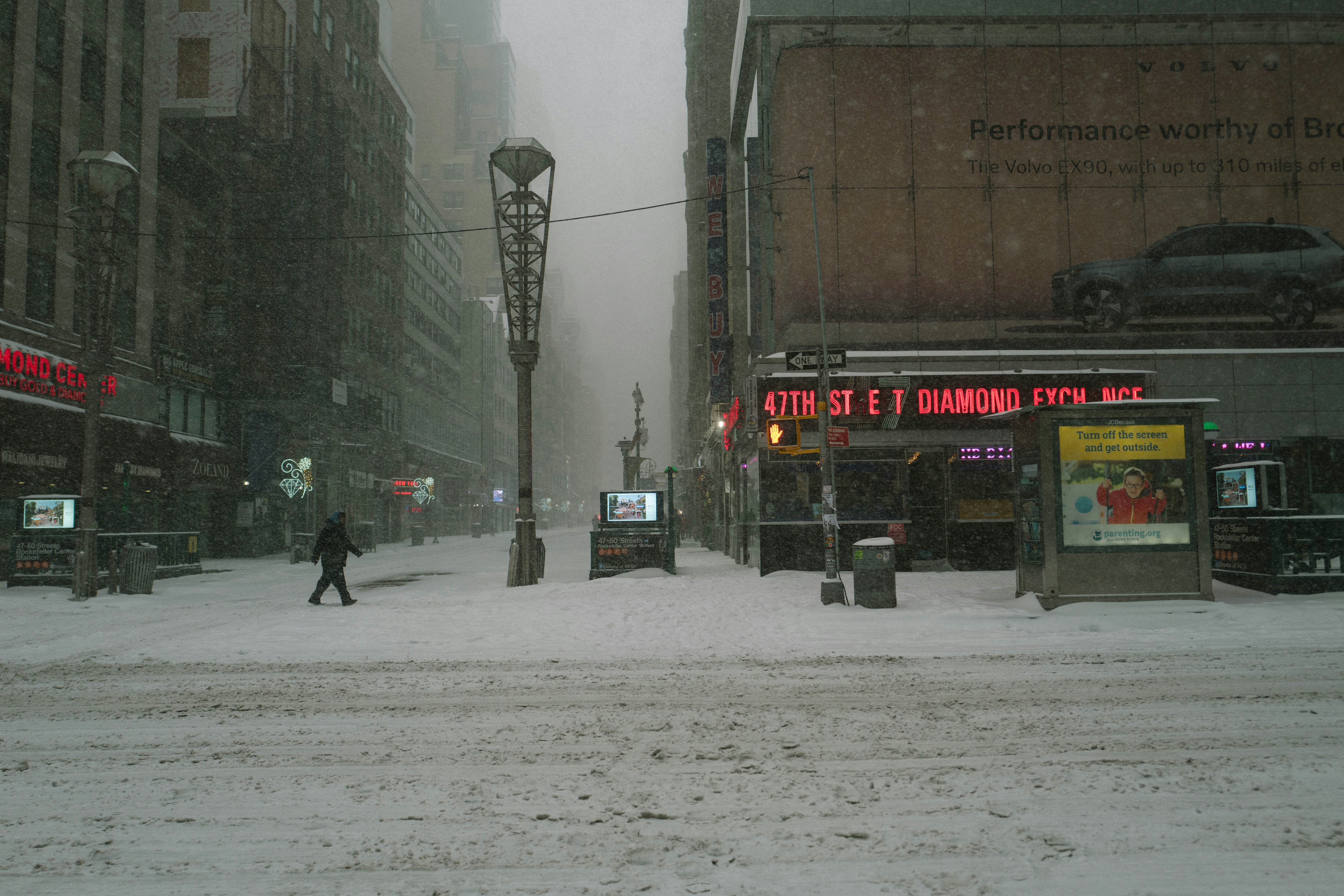 Snowfall Quiet in a Neon-Glowed City Crossing