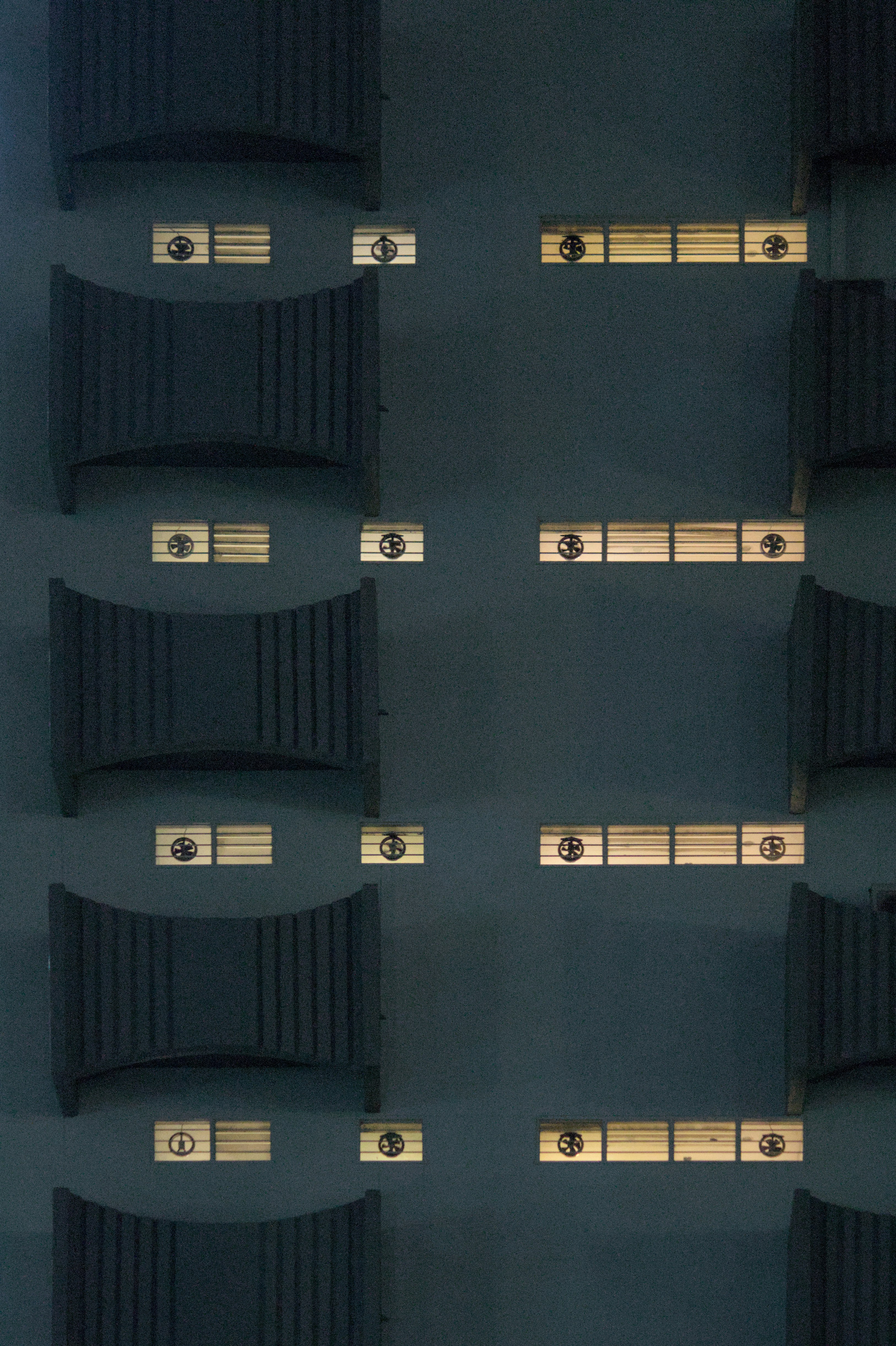 Shadowed Lounges: Repeating Blue Benches in an Overhead Grid