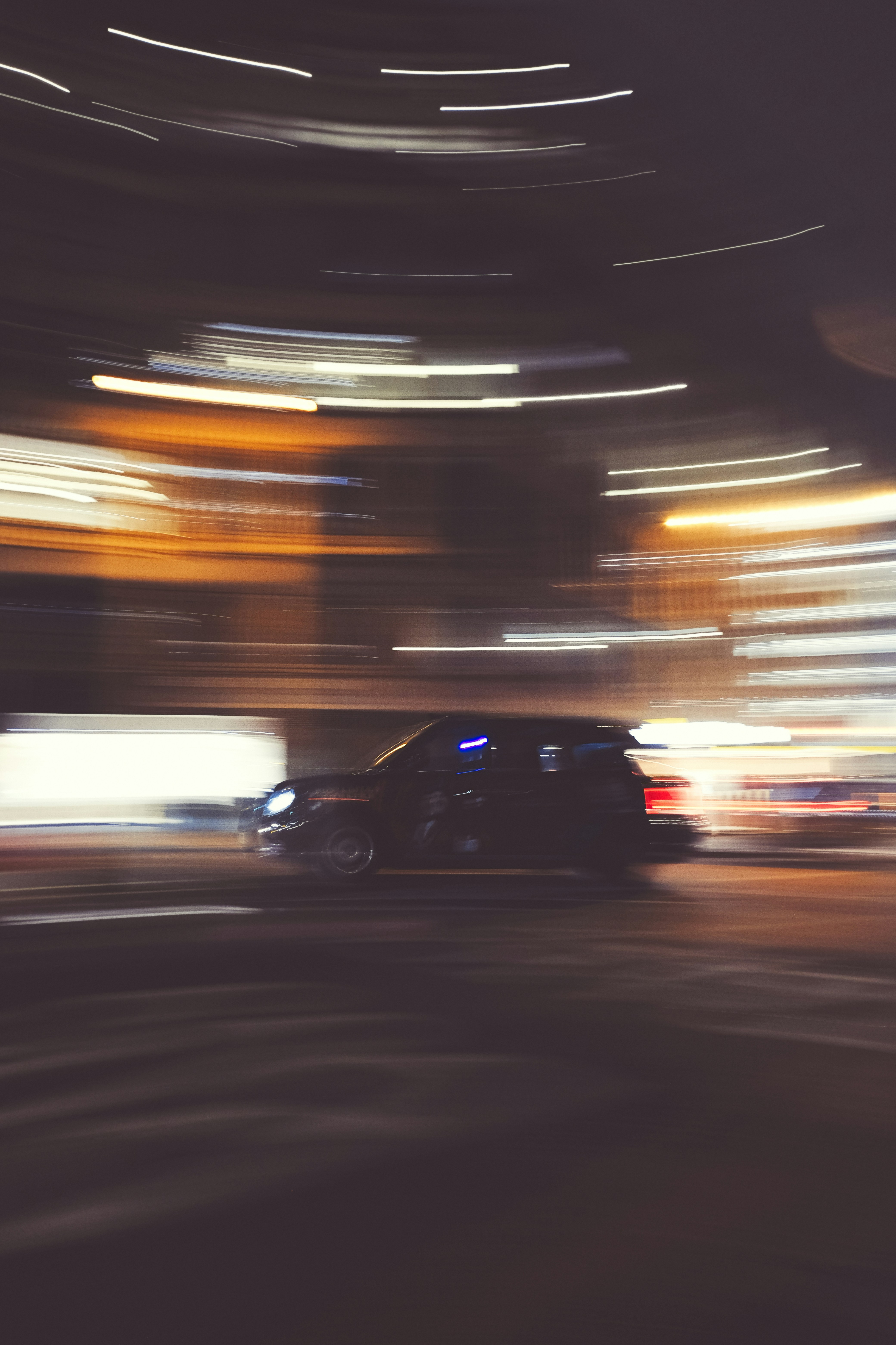 Midnight City Blur: A Moving Car in Echoing Lights