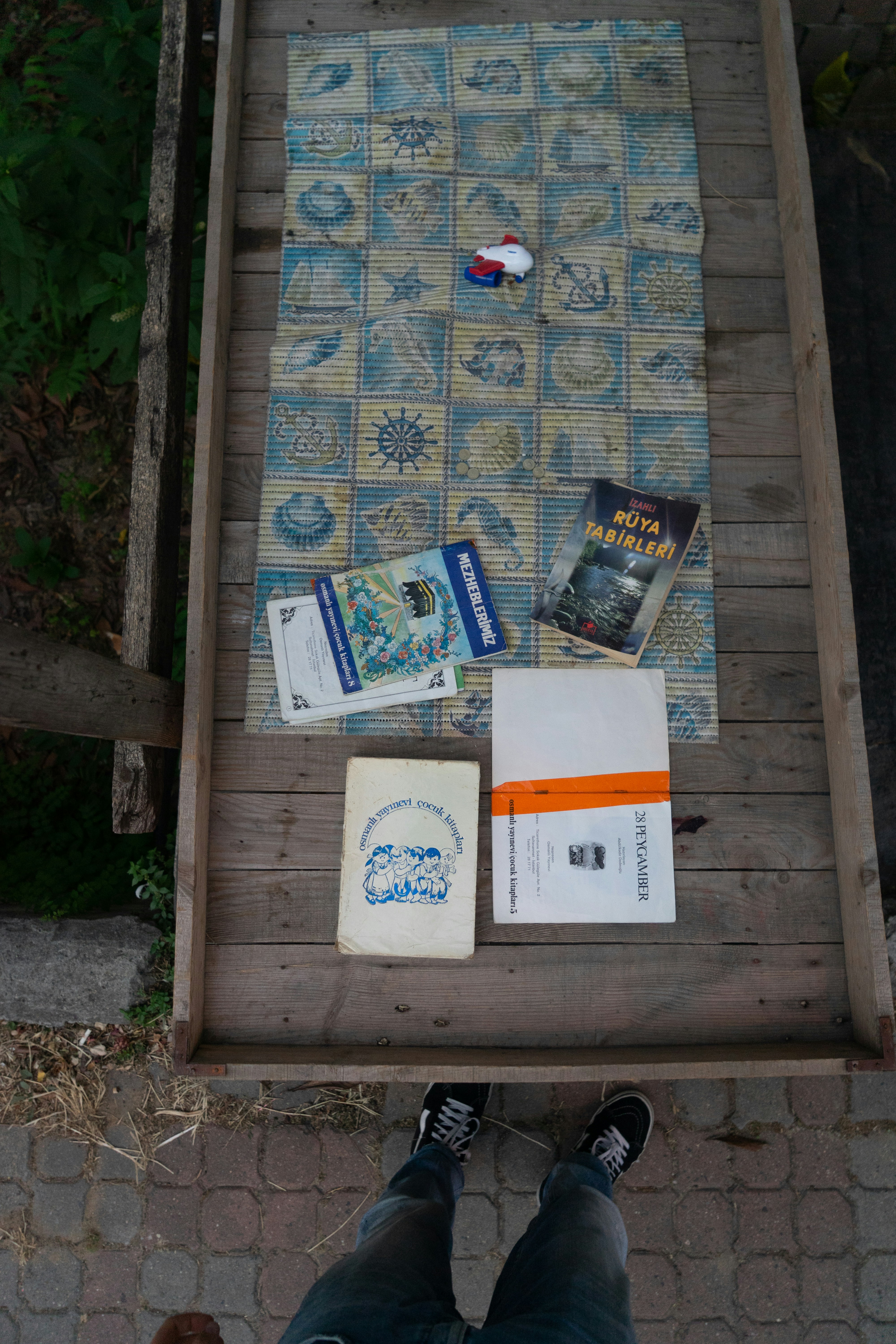 Mismatched Memorabilia on a Weathered Dresser of Steps
