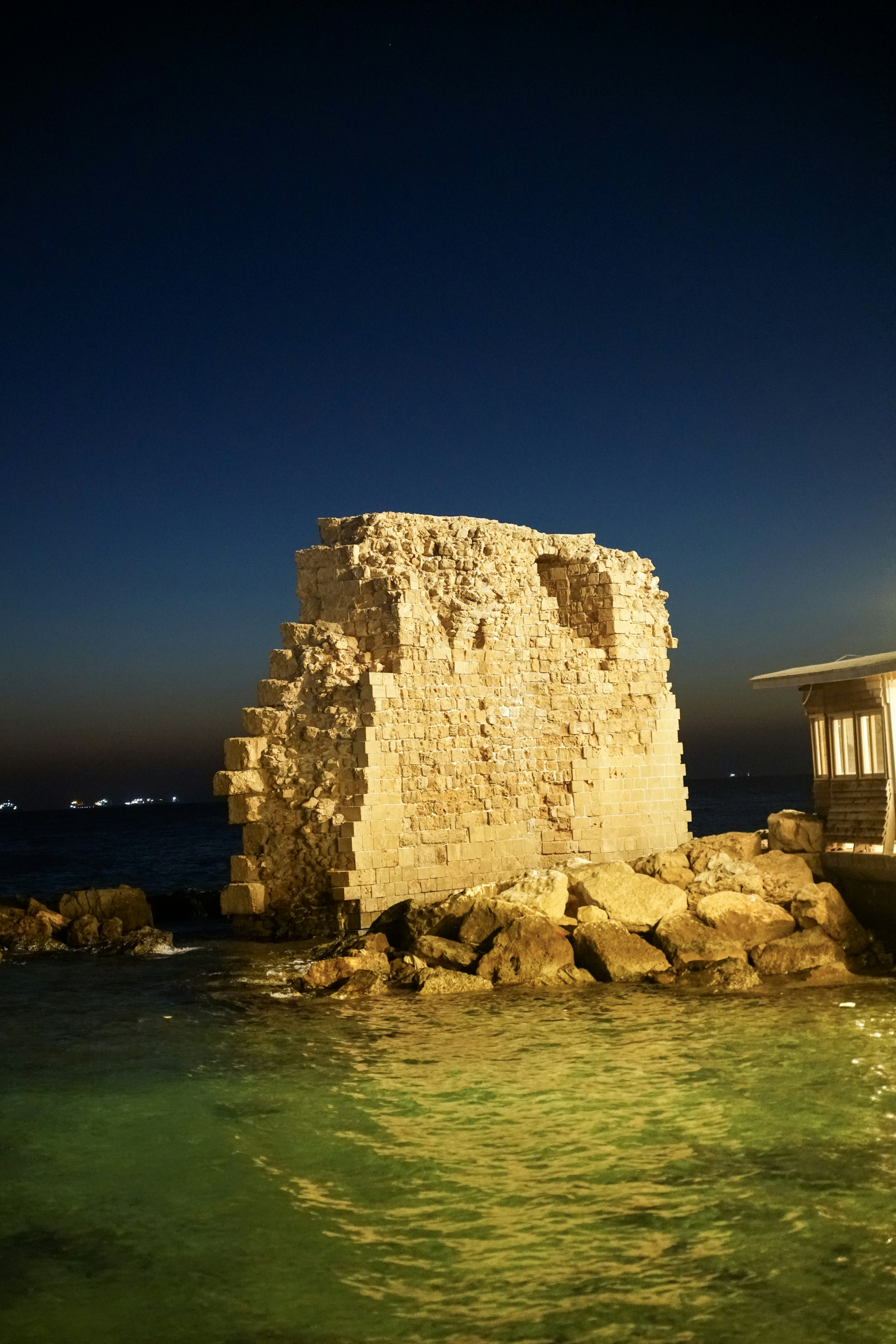Moonlit Ruins by the Sea: Stone Blocks and Distant Lights
