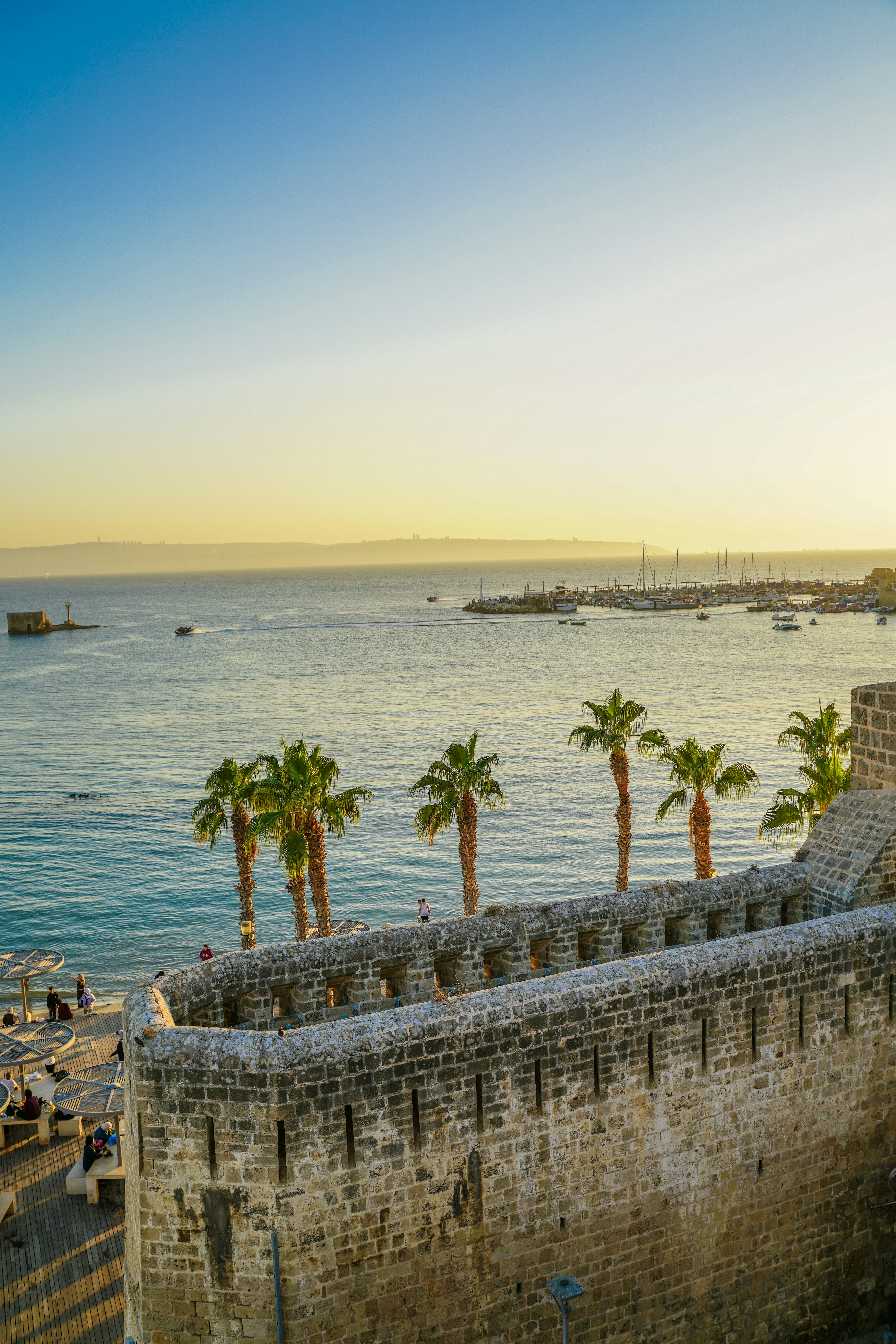 Cliffside Bastion Overlooking a Sunset Harbor