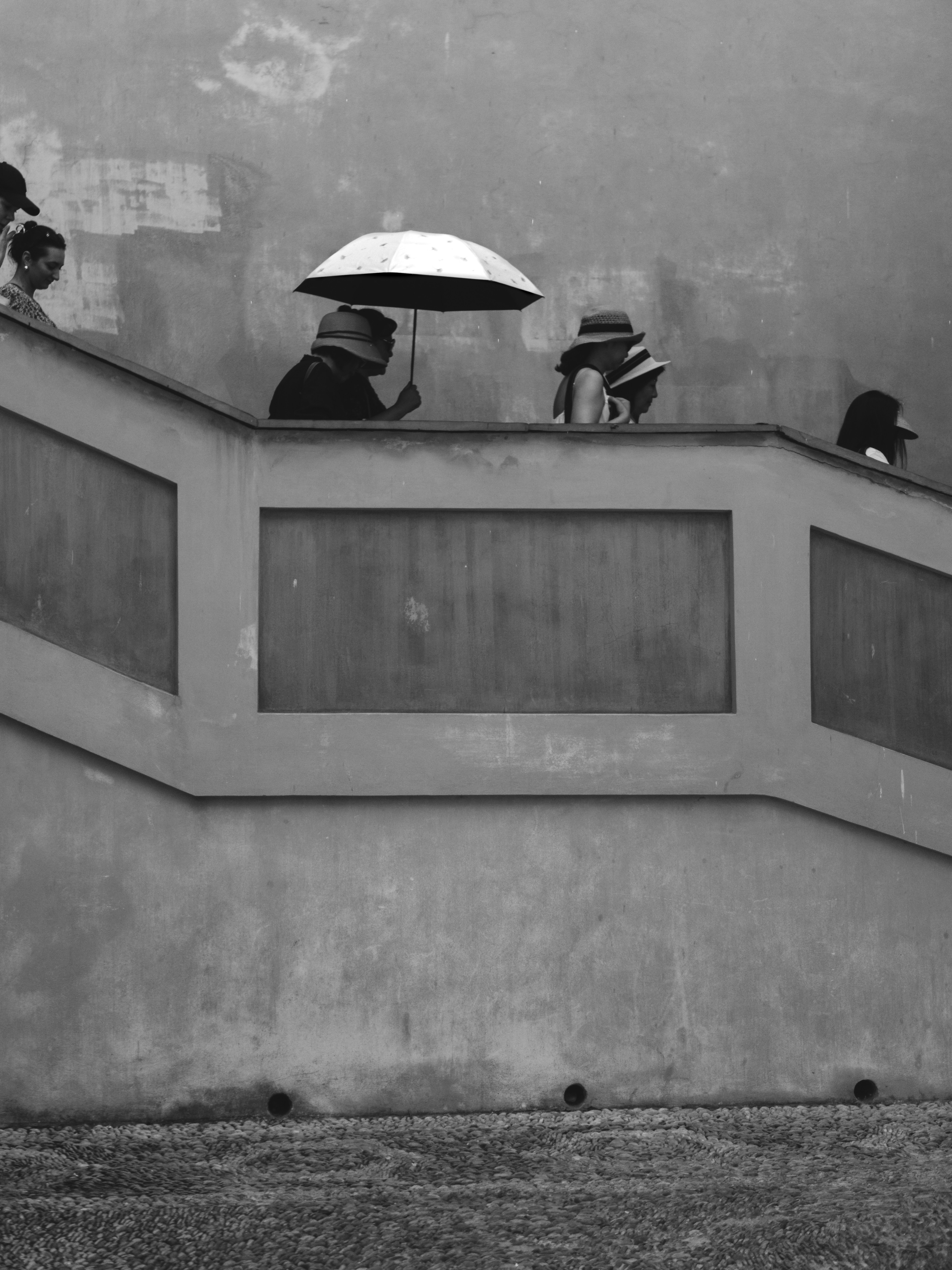 People with umbrellas on a staircase
