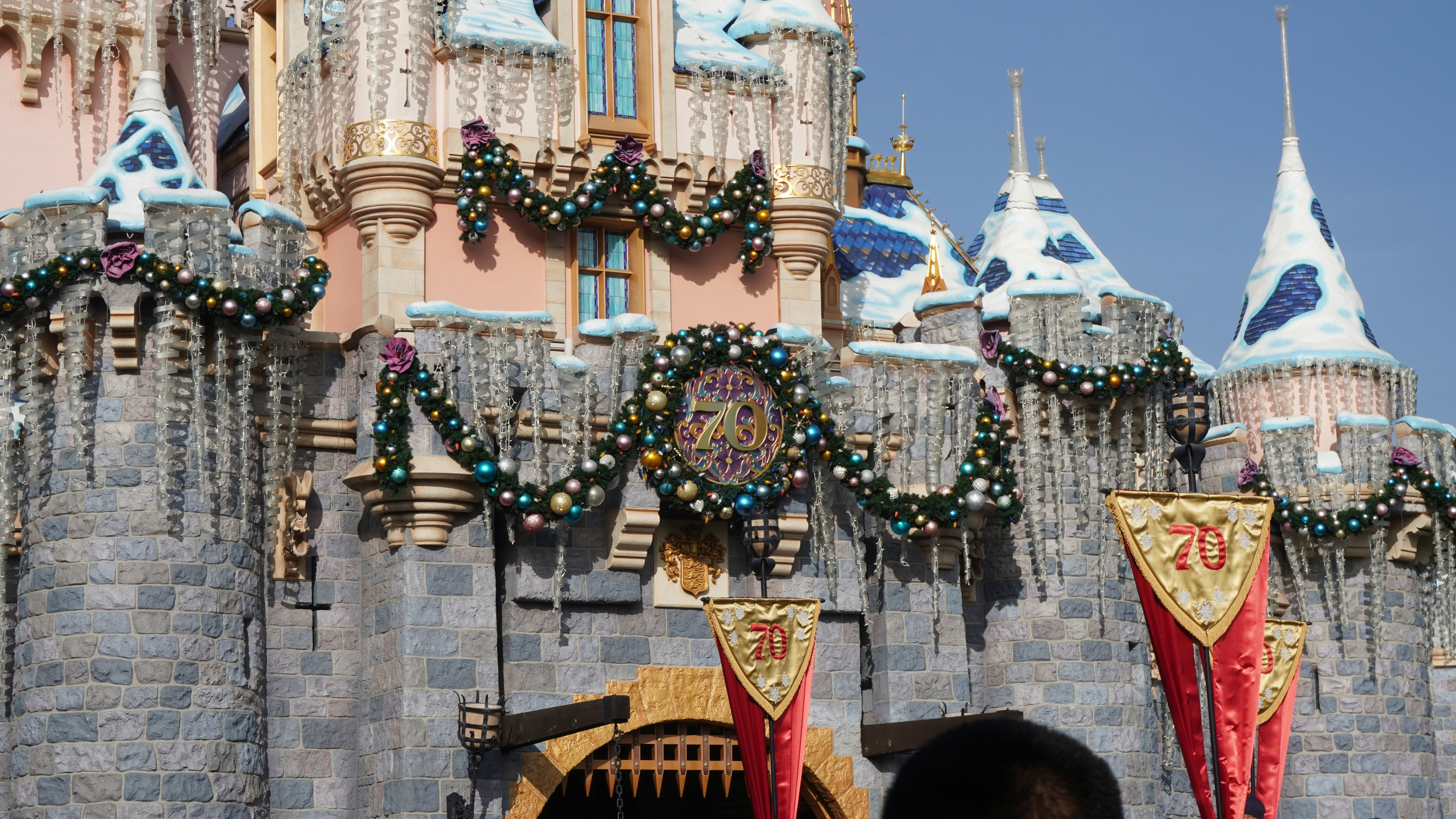 Castle Facade Draped in Holiday Garlands at a Theme Park