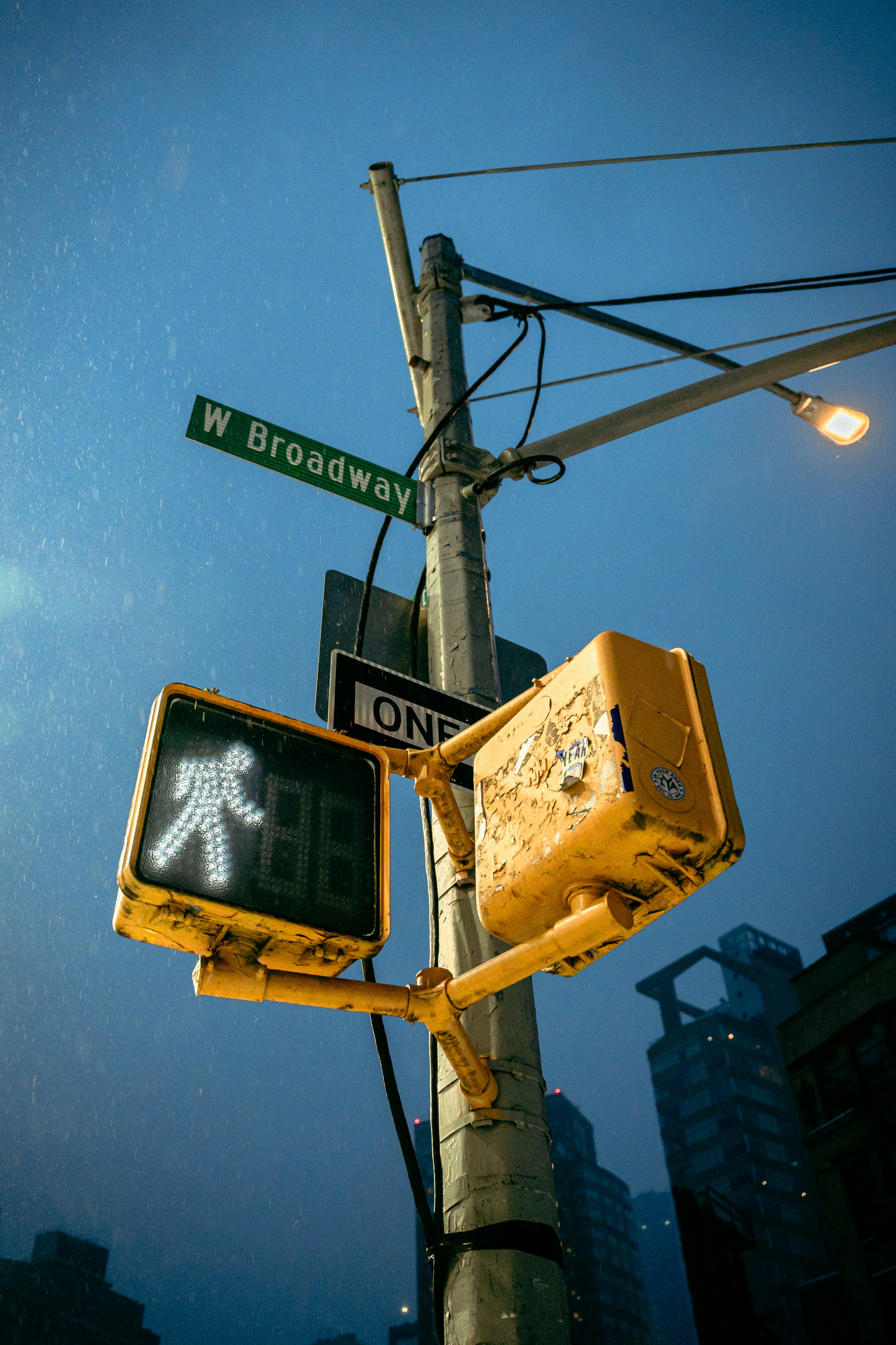 Urban Intersection: Rain, Railings, and a Neon Sign of Green Streets