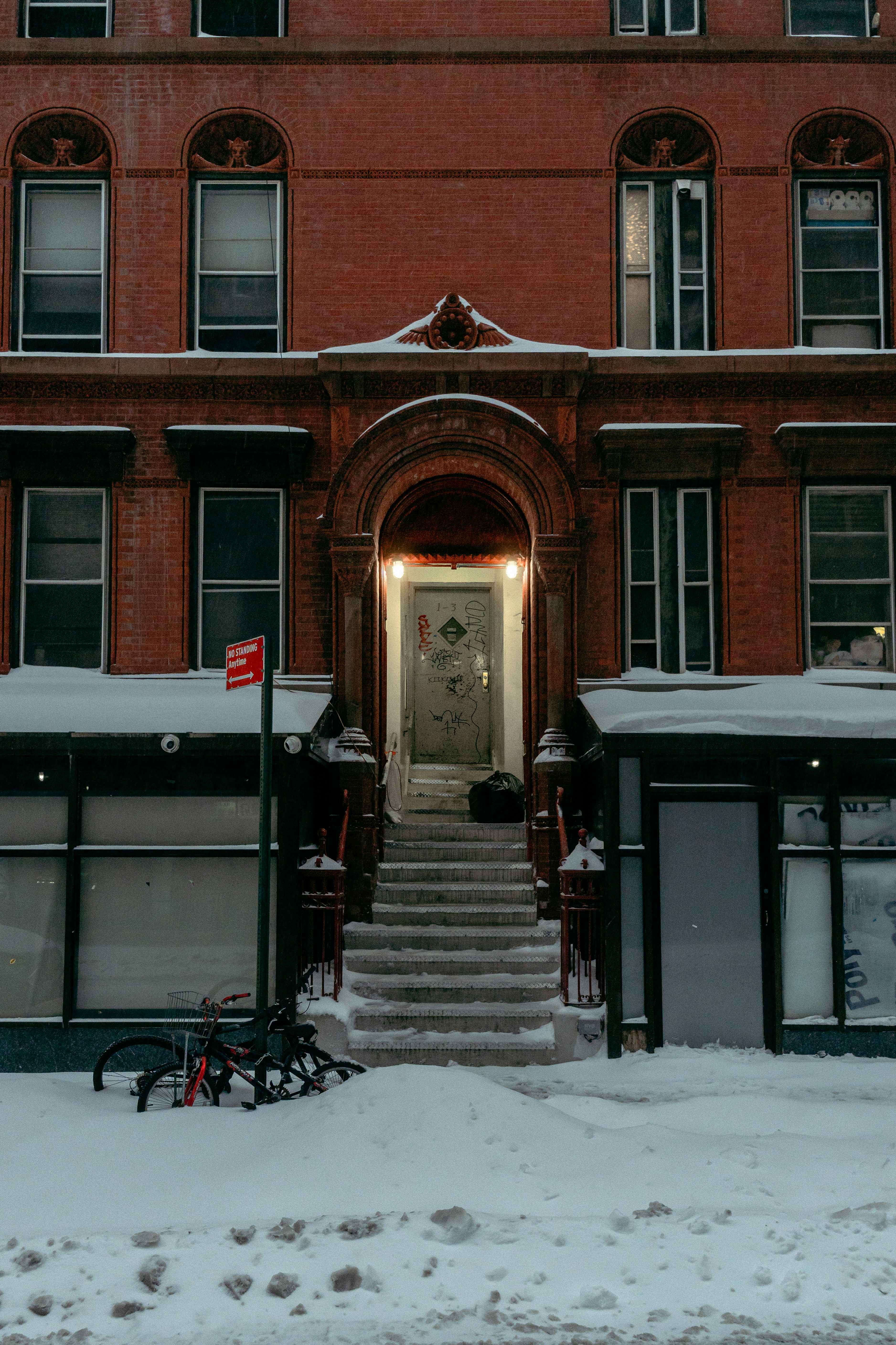 Snowy entrance to a brick building at dusk photo – Free Architecture ...