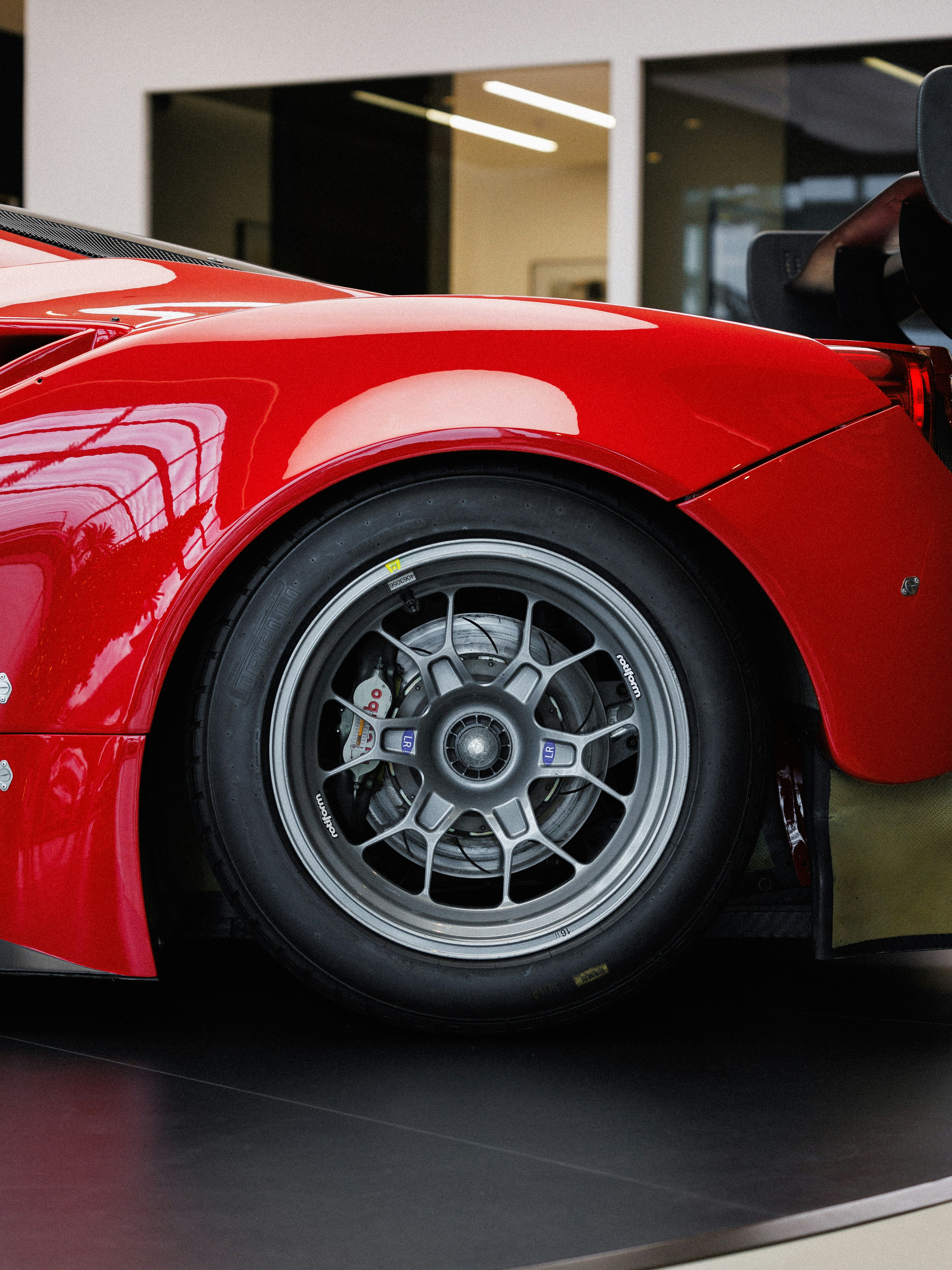 Red Sentinel: A Gleaming Race Wheel Anchored by Factory-Bs Aluminum