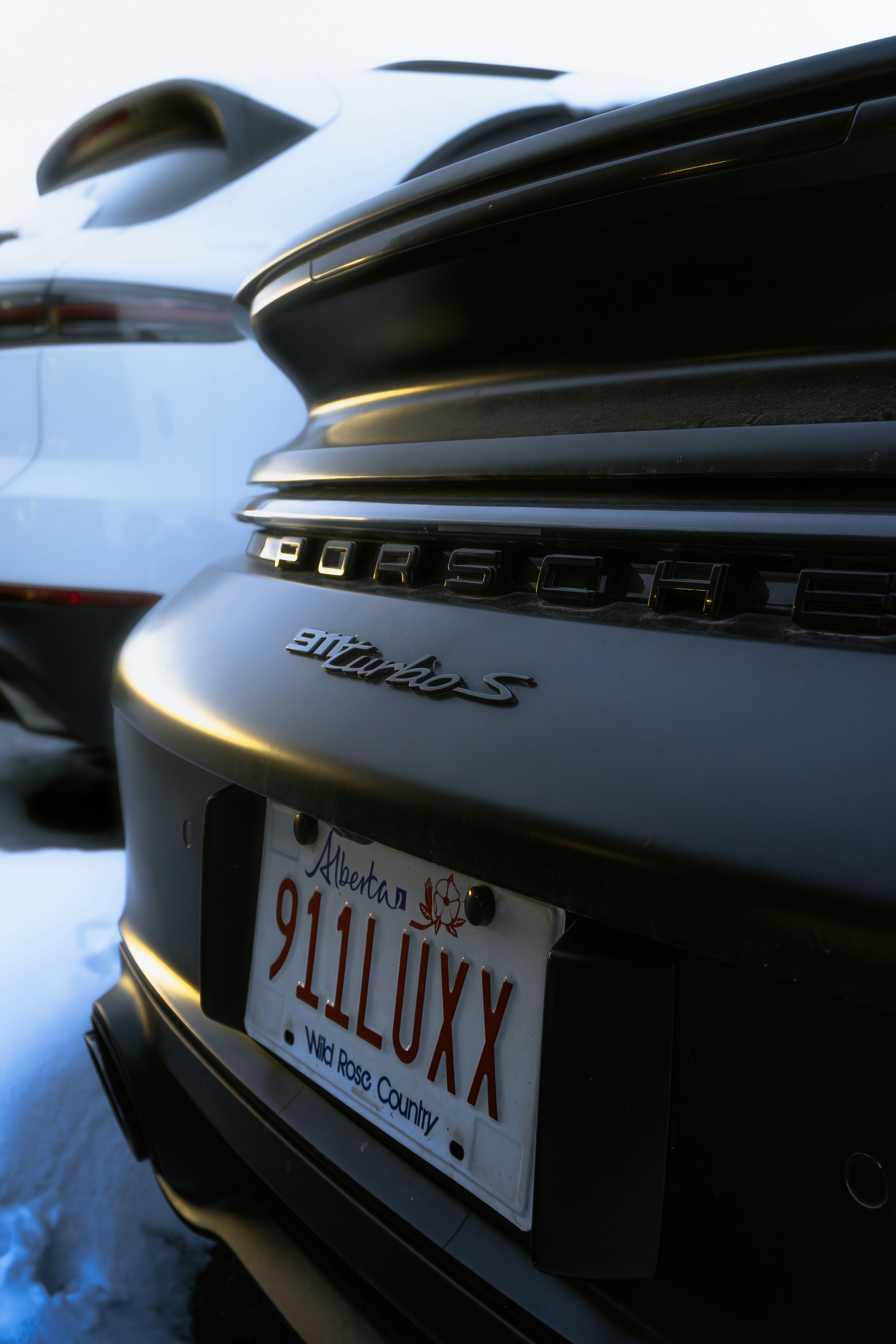 Stilled Curves: A Porsche 911 TurboS tail tucked in a quiet lot