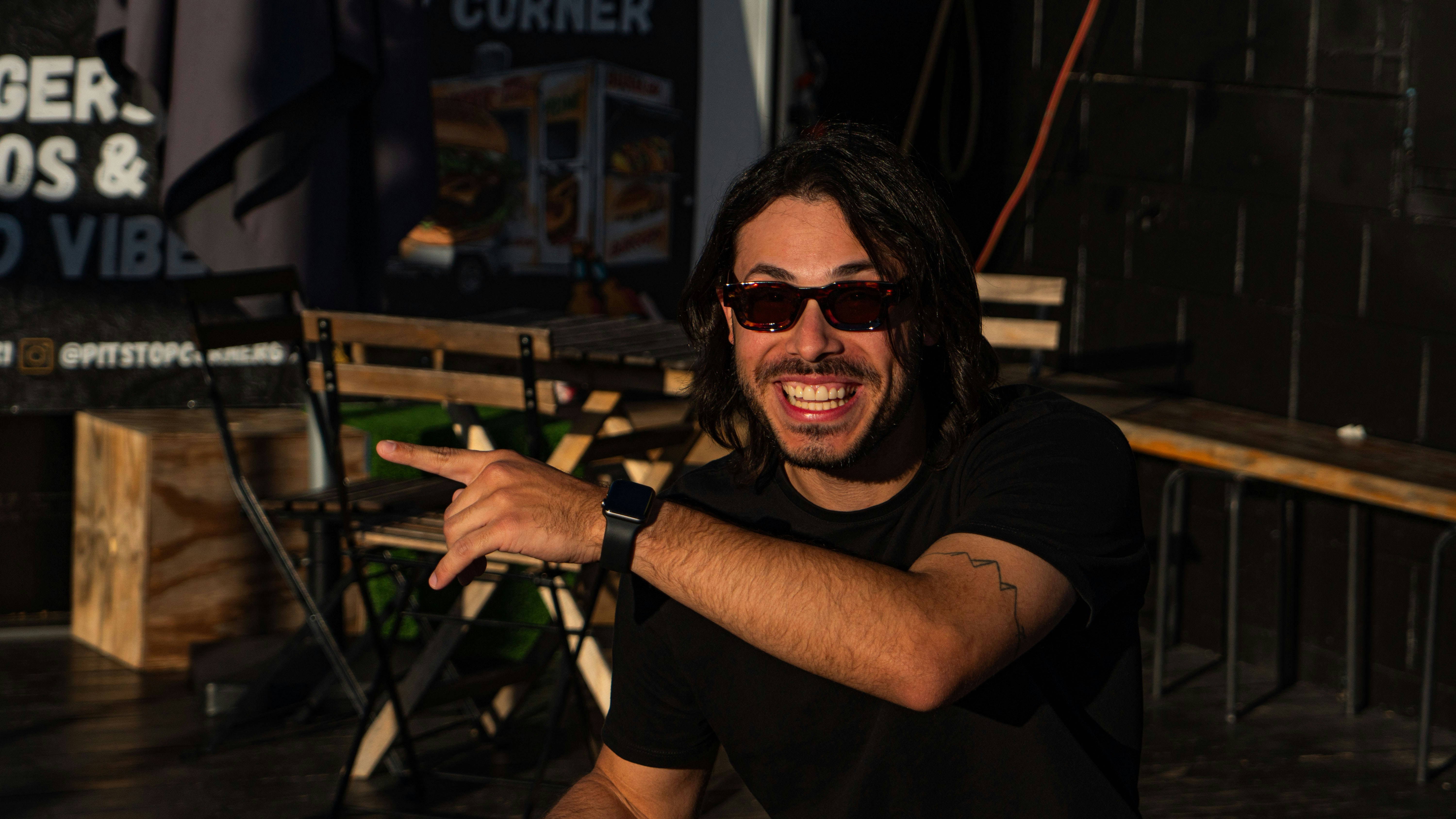 Mid‑Smile Moment on Stage: A Charismatic Guitarist of the Backstage