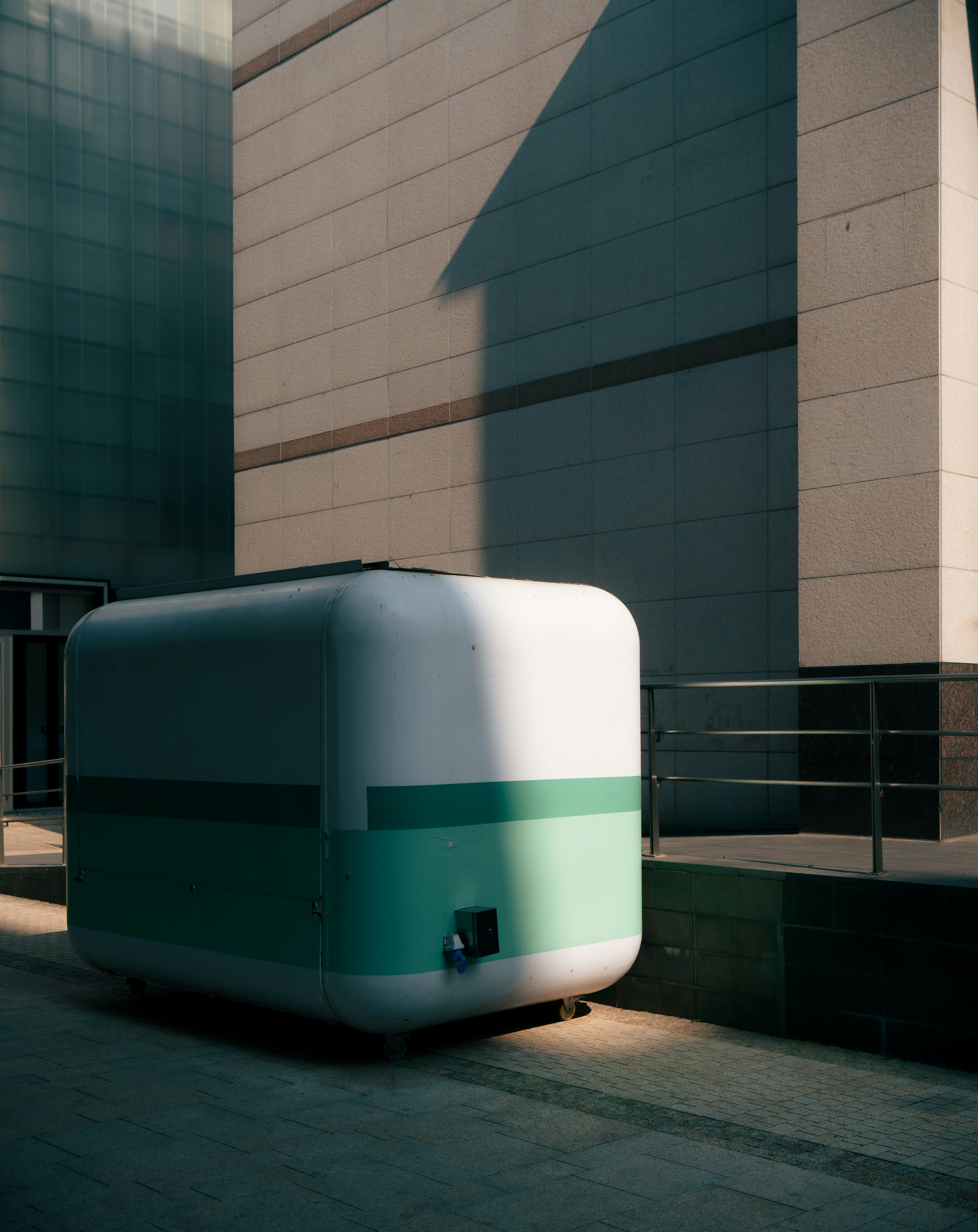 Industrial Capsule under Cast Shadow