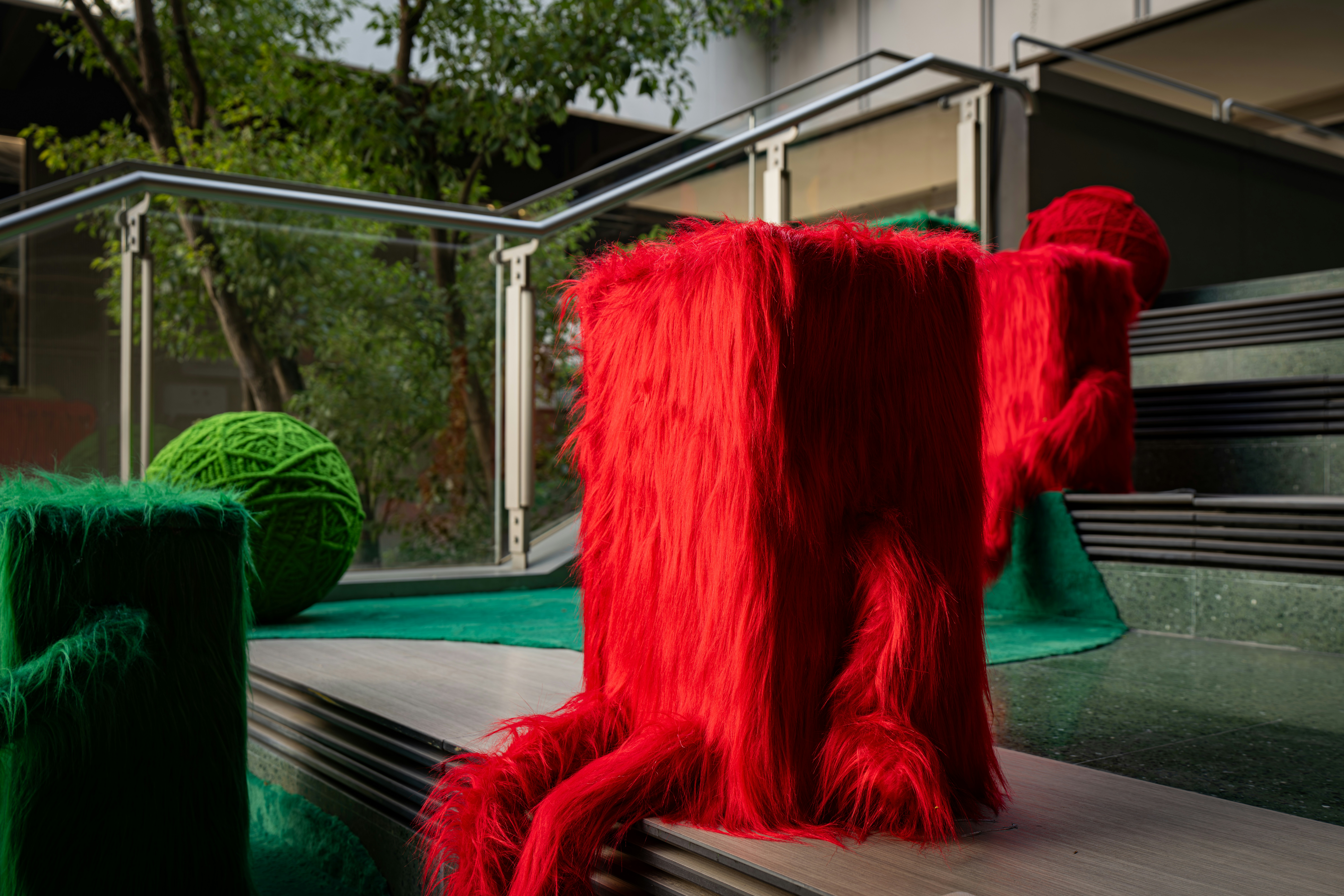 Scarlet Threads on Concrete: An Abstract Seating Scene