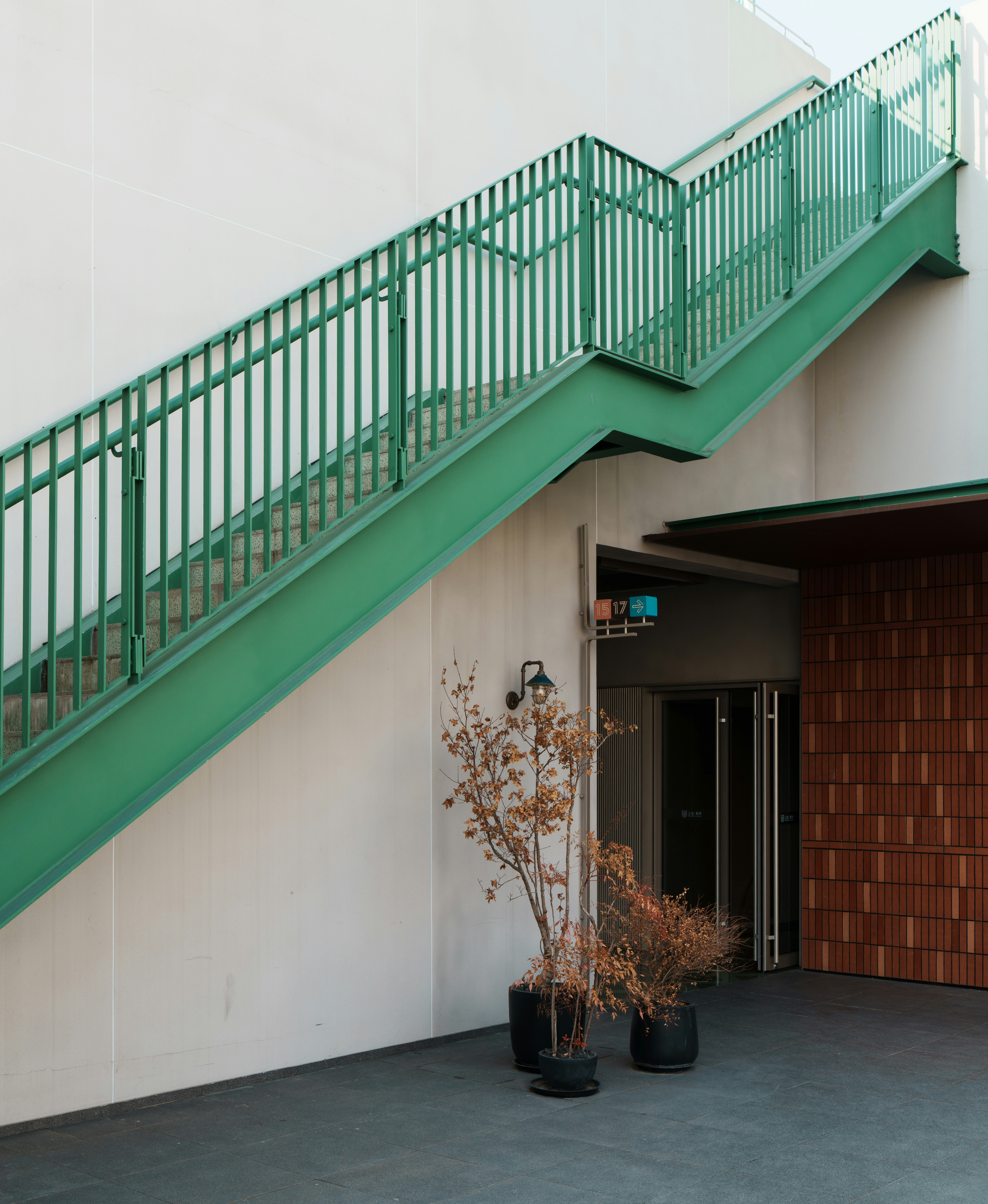 Emerald Staircase Ascending a Quiet Building Facade