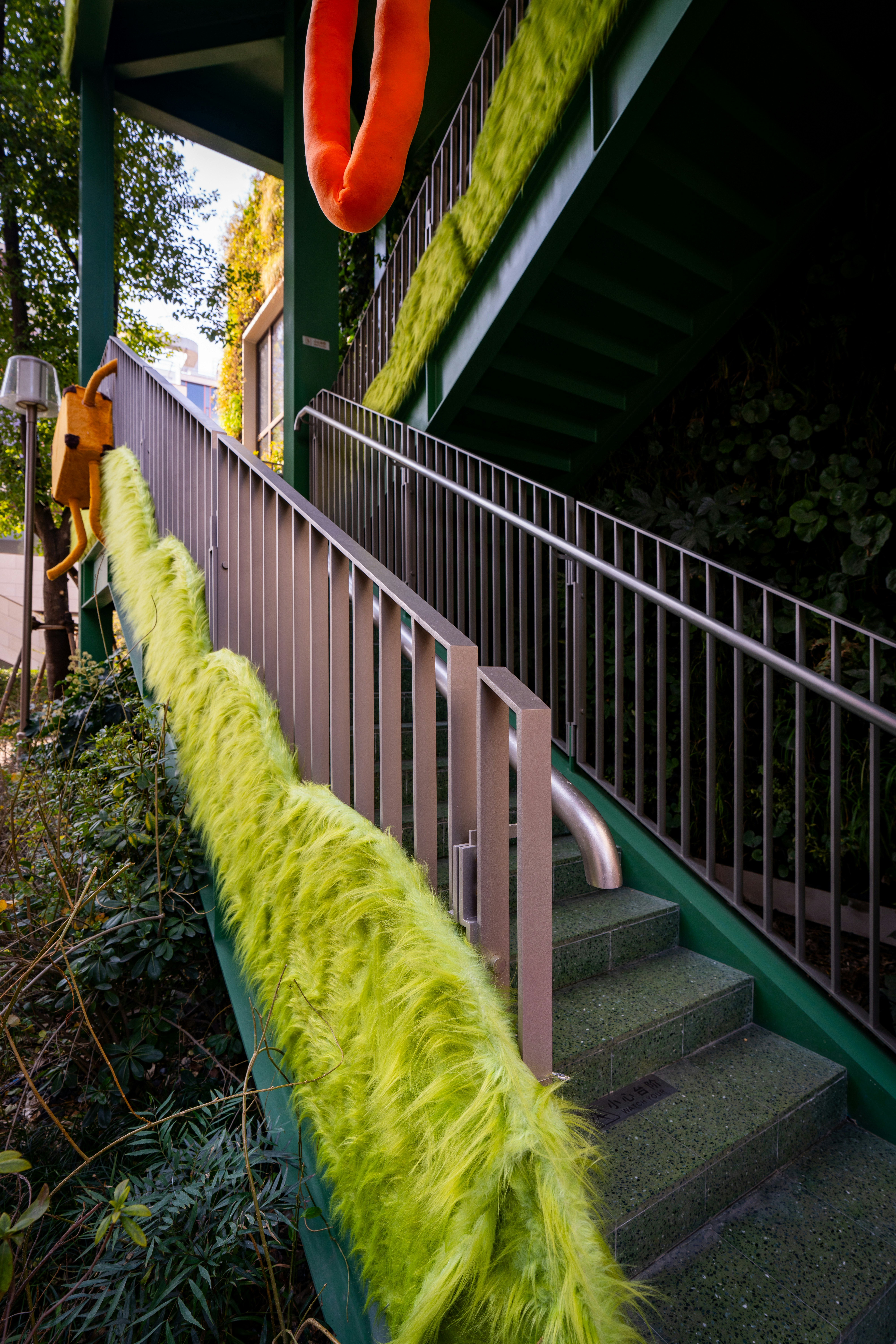 Neon-green Handrails Loom Over Quiet Stairs