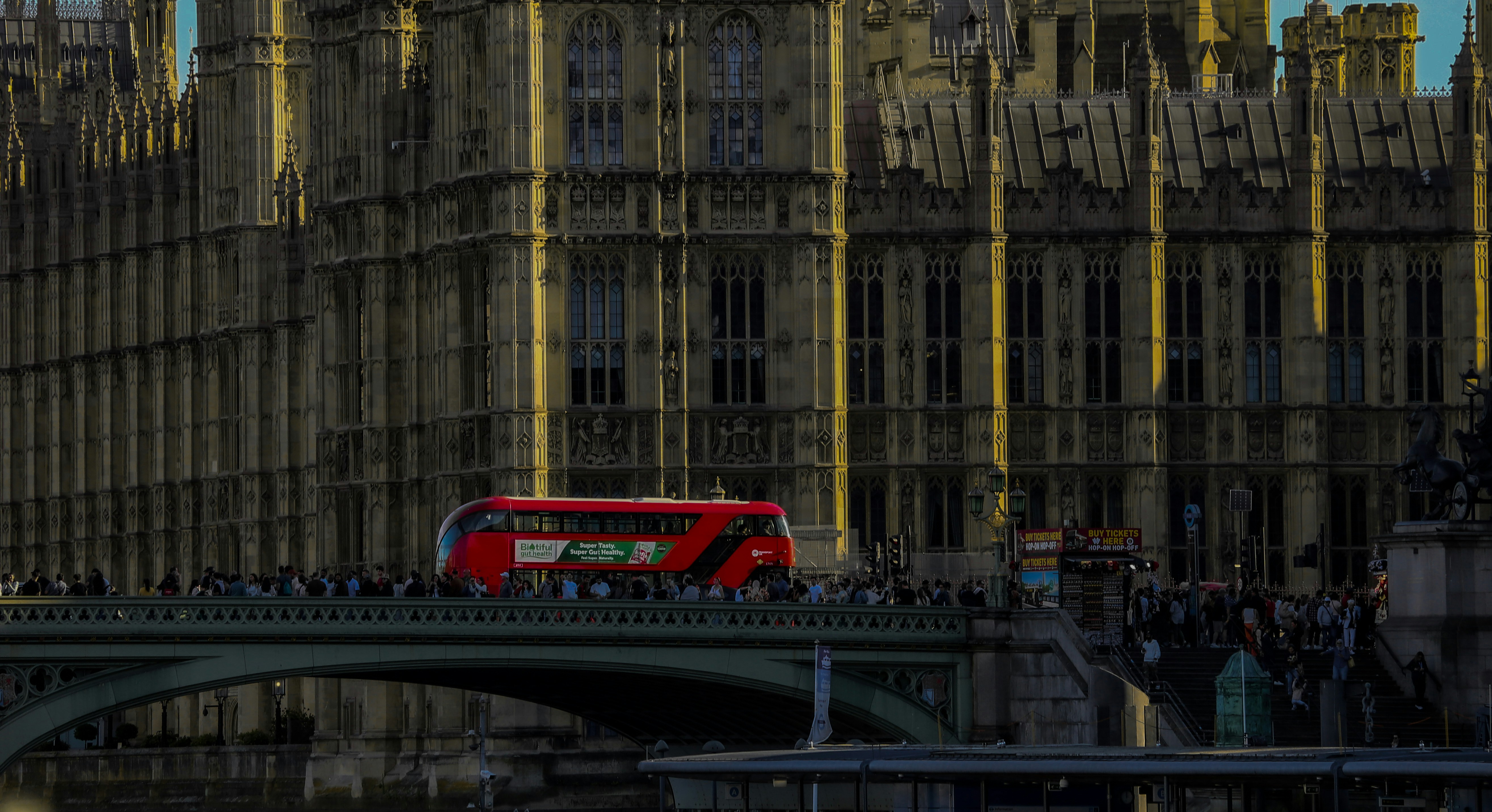 Crimson Transit: A Red Double-Decker Crossing Westminster Bridge