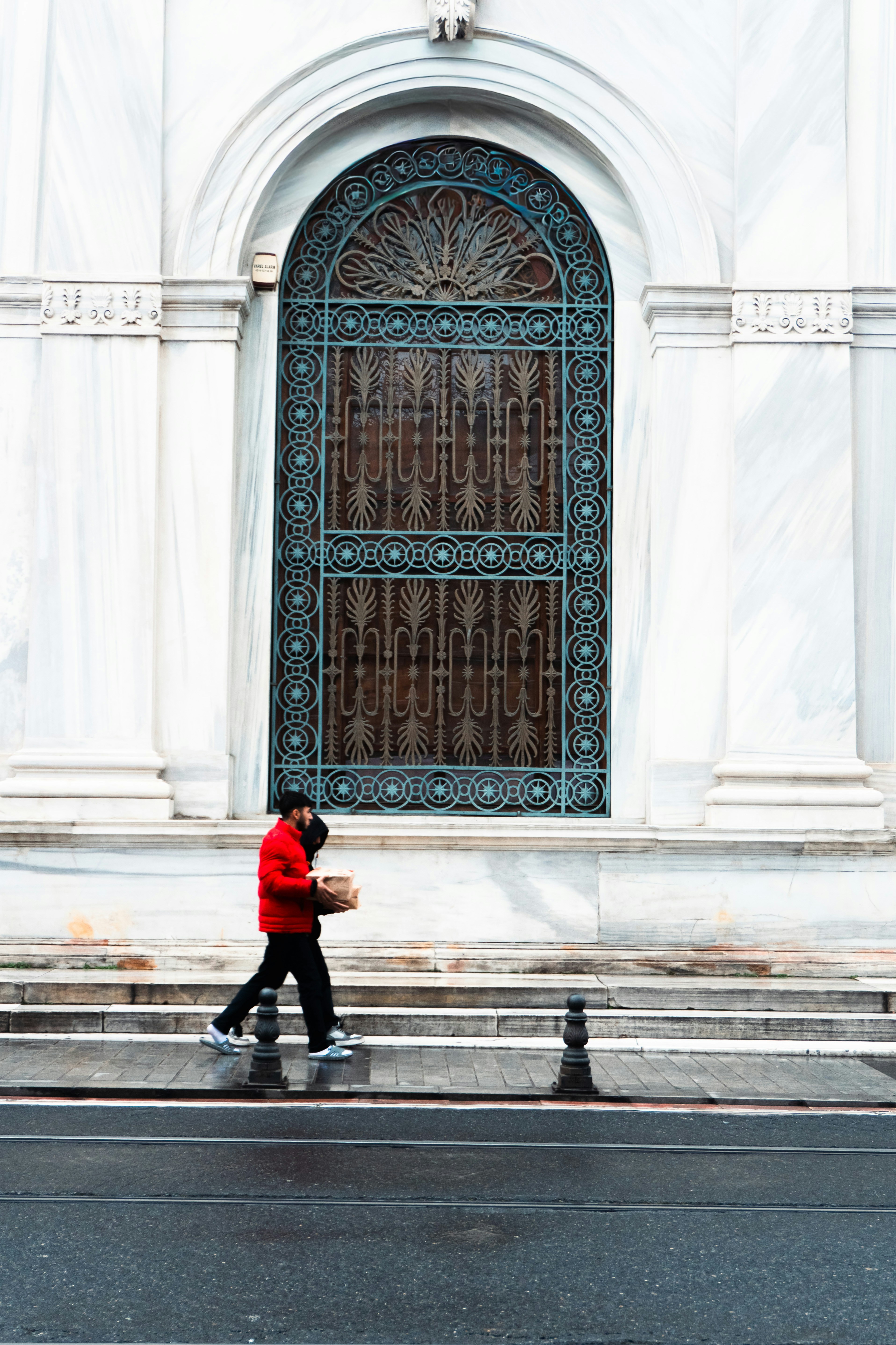 Red-Clad Messenger in Front of The Marble Gate