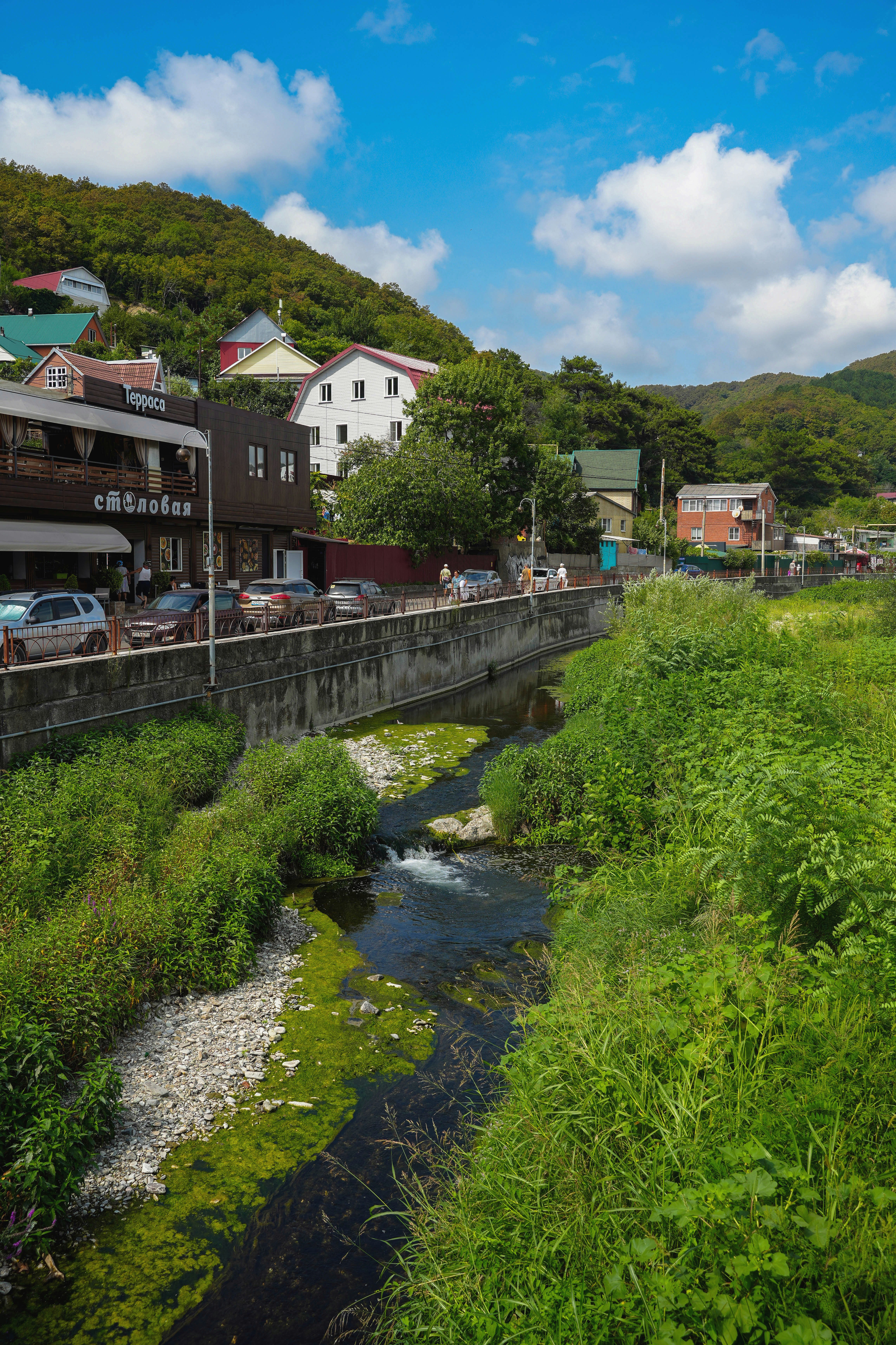 Quaint riverside village under a sunlit sky