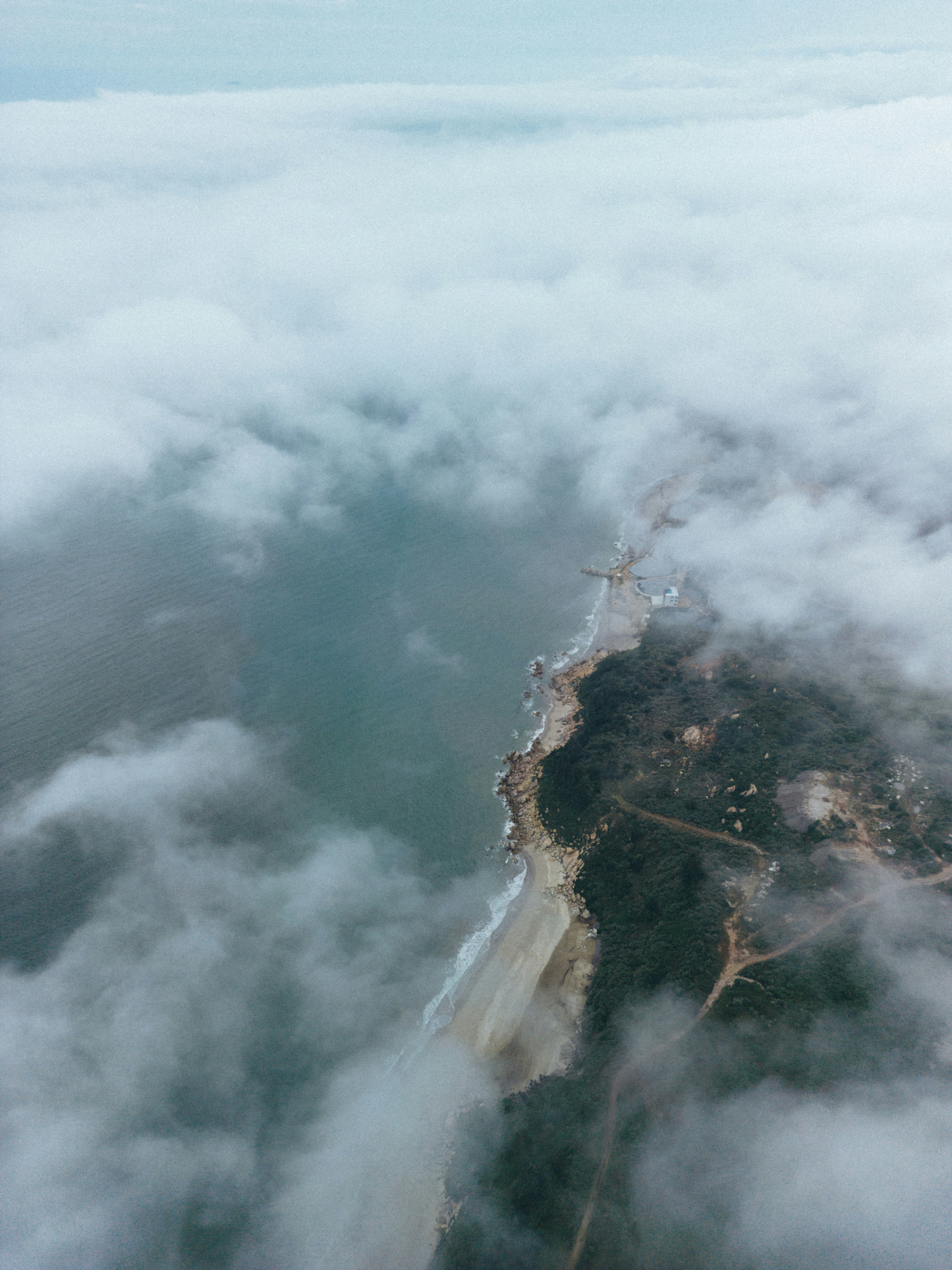 Coastline in the Clouds: Aerial Cut Along the Turquoise Shore
