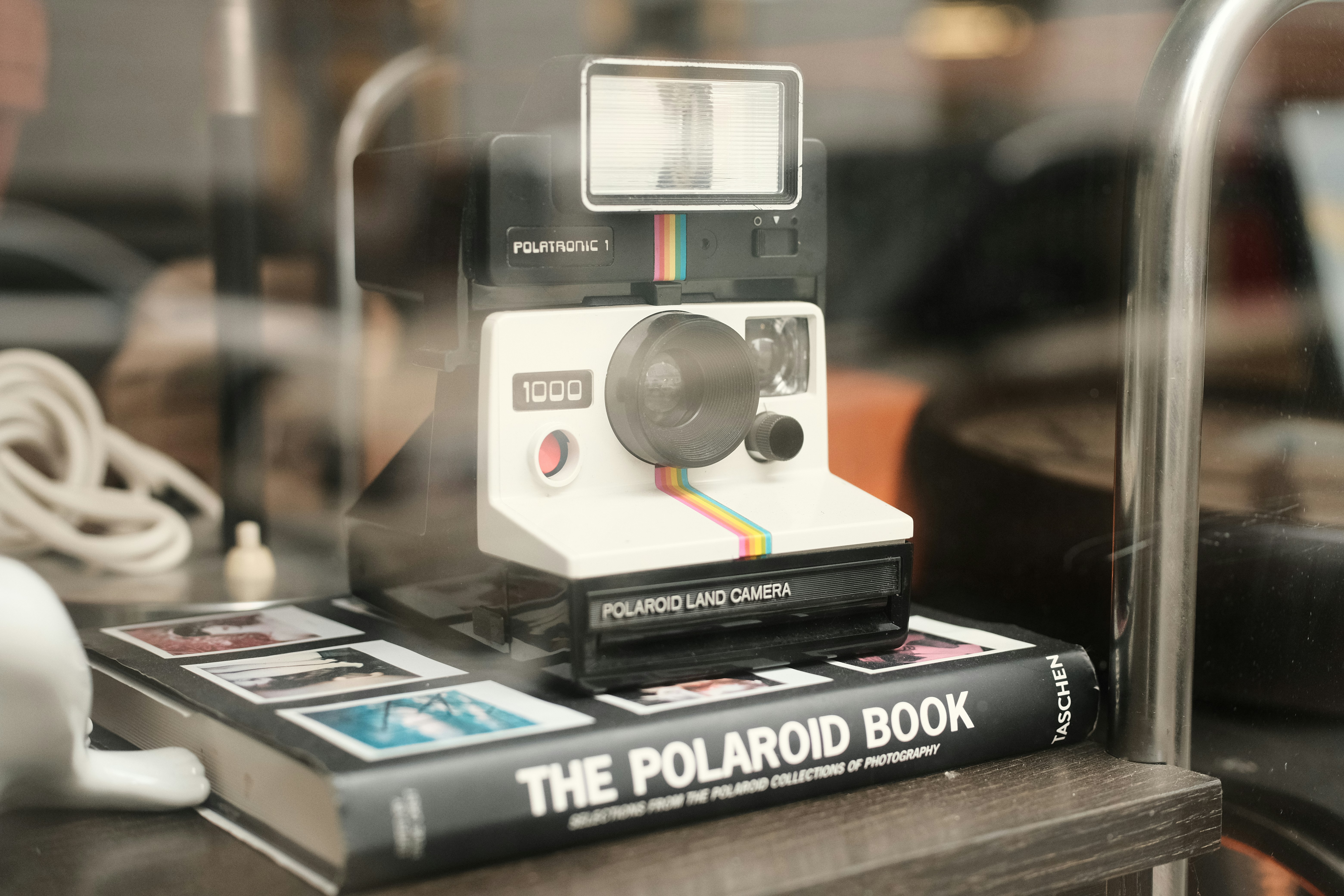 Polaroid nostalgia: a retro instant camera perched atop a book