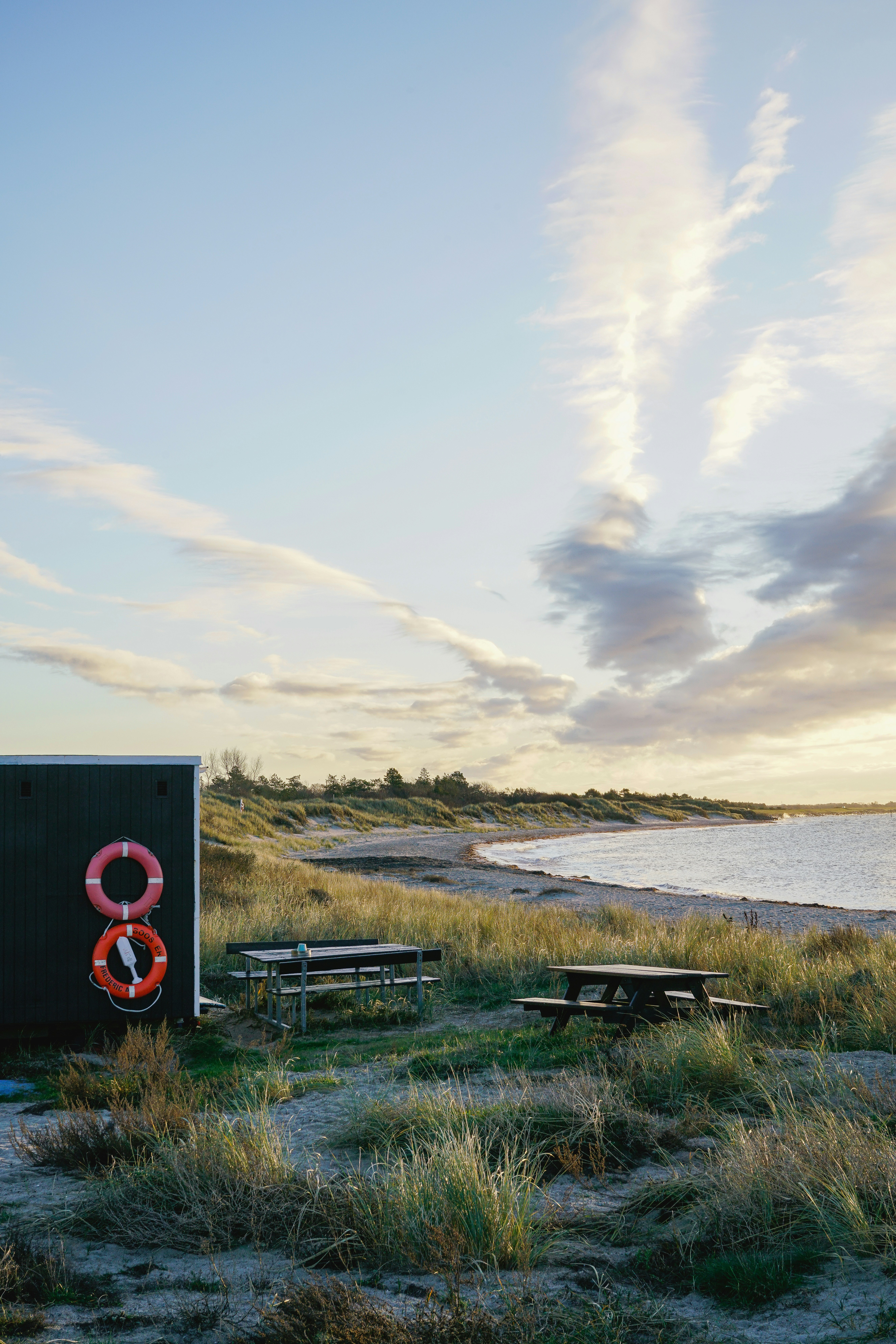 Lifebuoys by the Dunes: Quiet Coastal Rest at Sunset