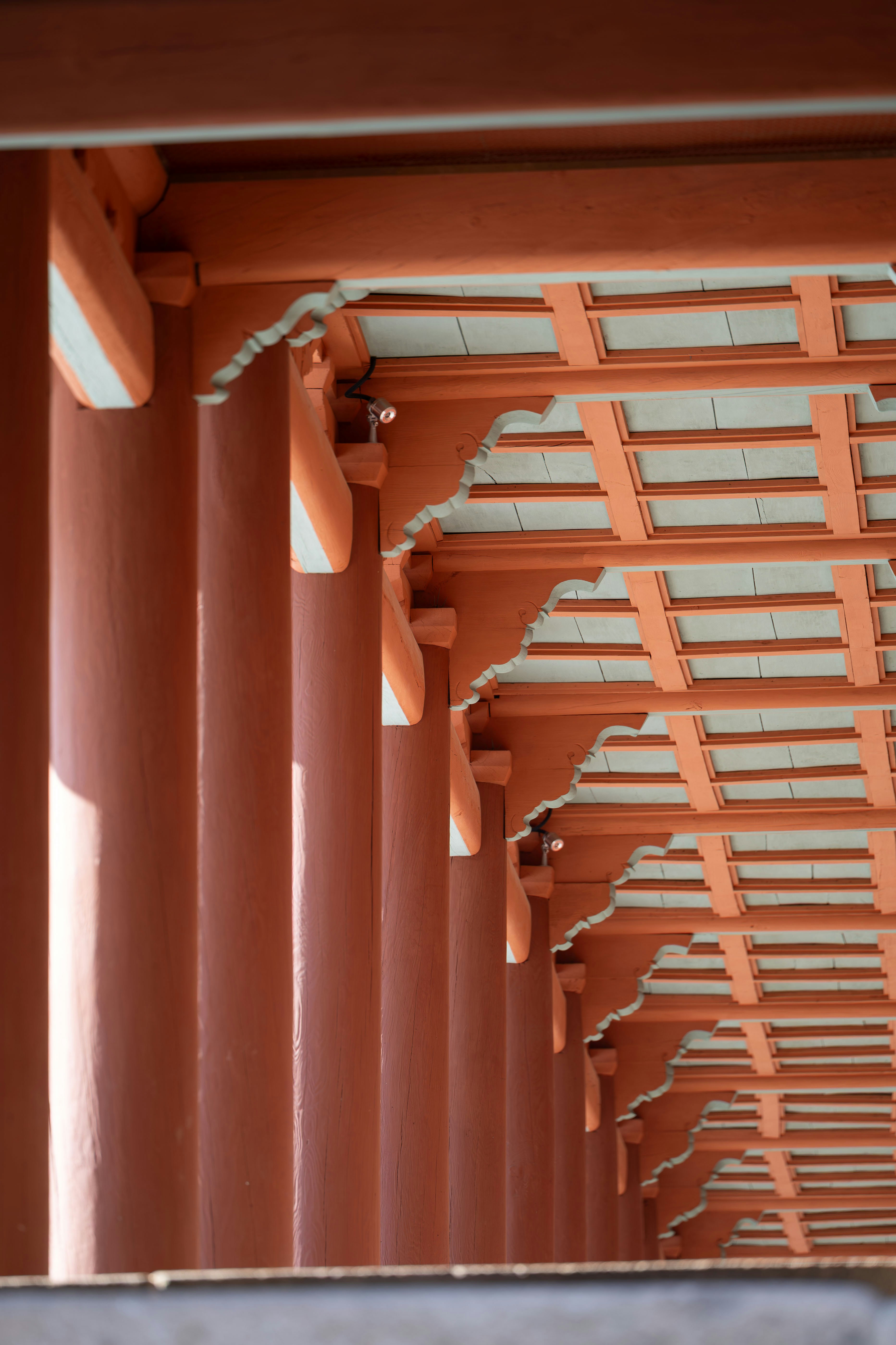 Echoes of Red Columns: A Repeating Corridor of Painted Beams