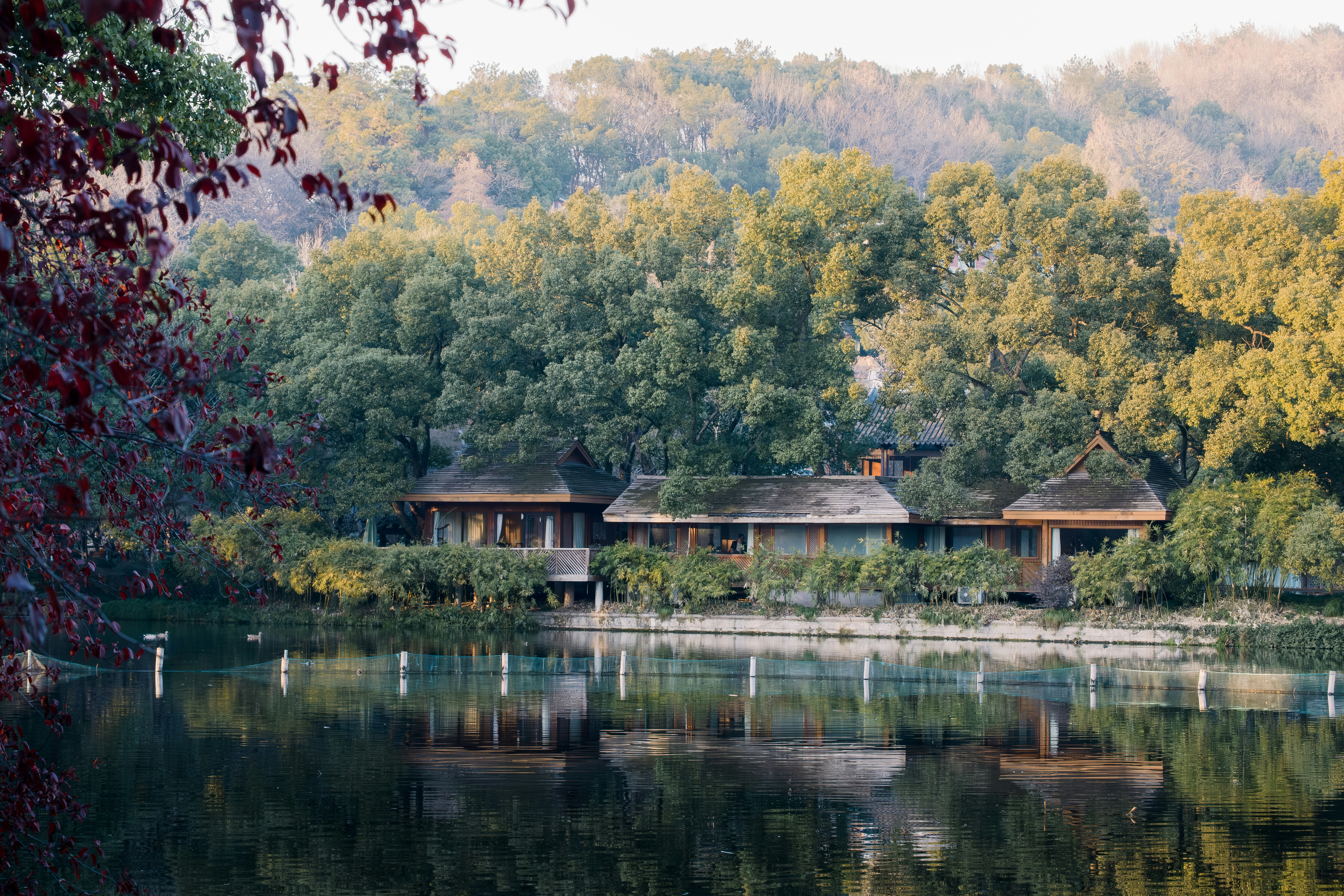 Autumn Reflections at a Tranquil Lakeside Pavilion