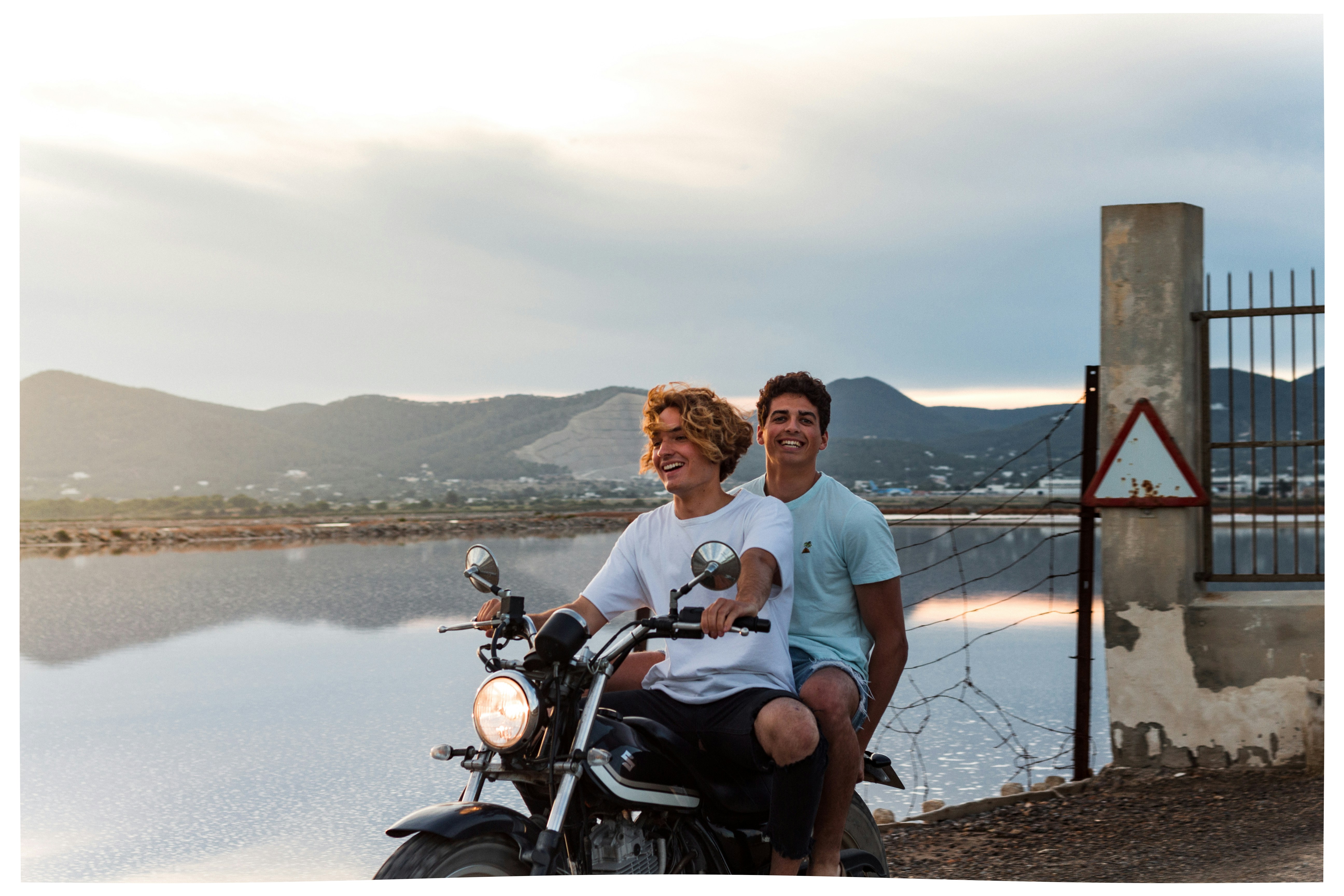 Sunlit Ride: Two Friends on a Quiet Coastal Road