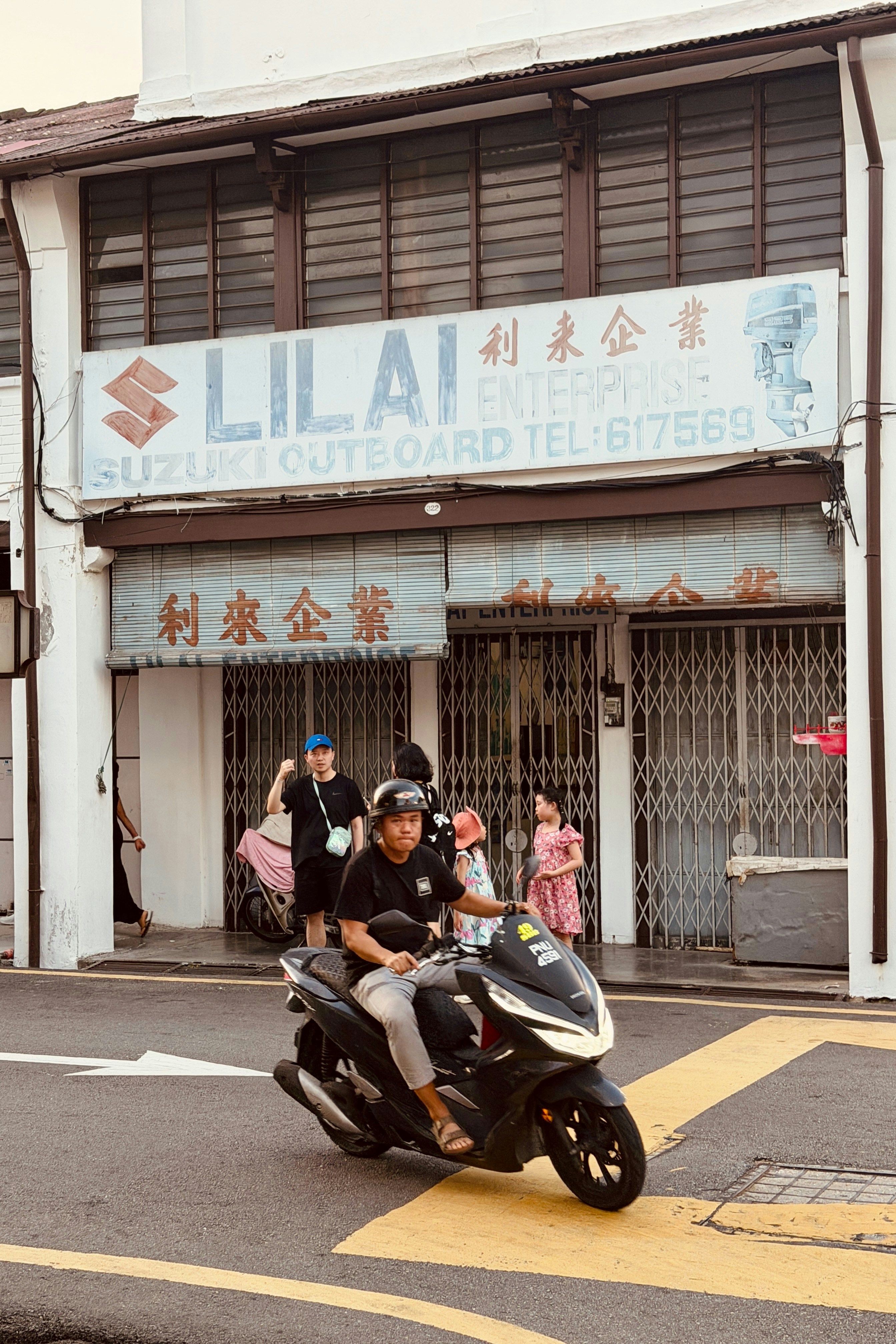Scooter in Front of a Faded storefront Sign