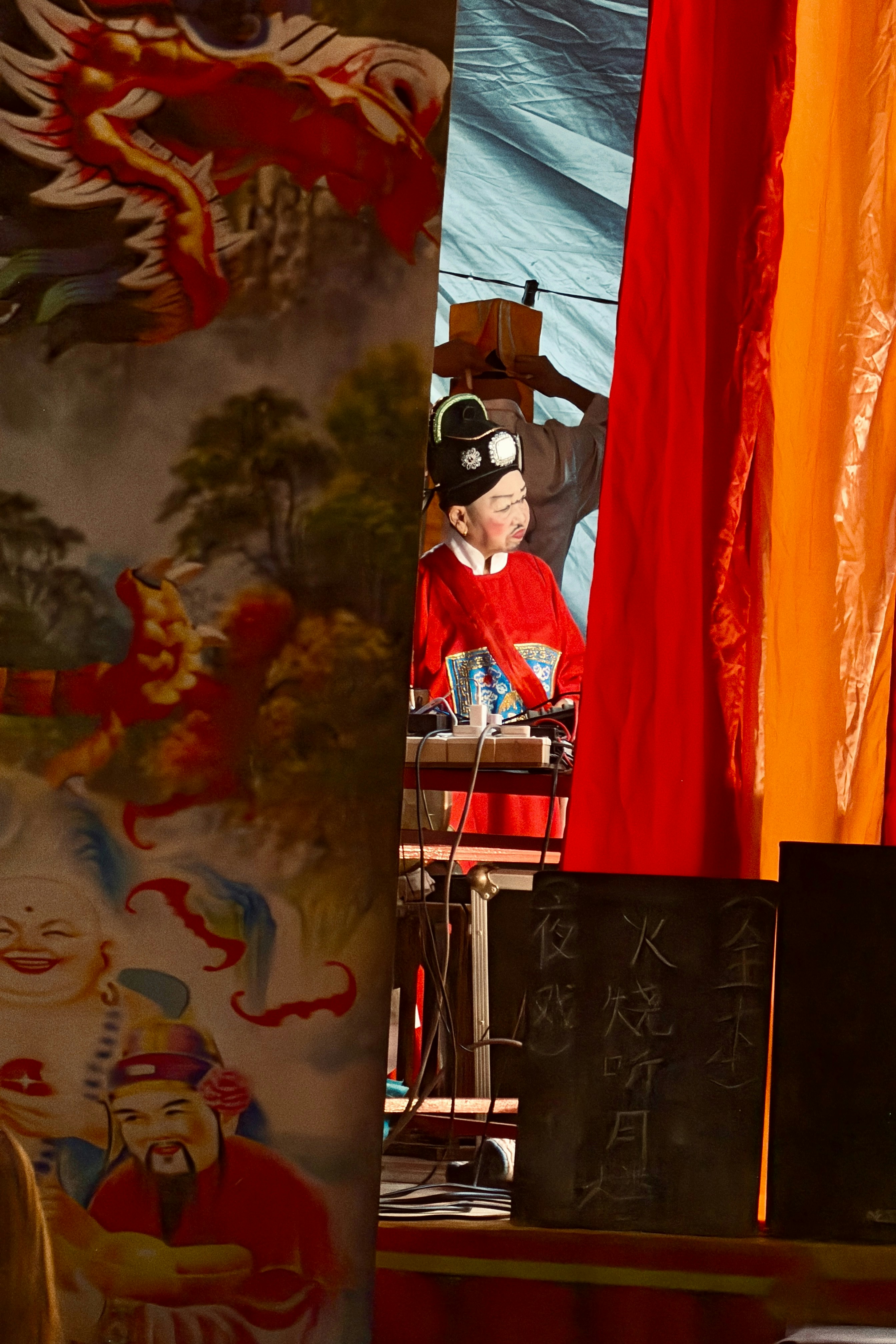 Stage Curtain and Performer: Behind-the-Scenes Moment at a Traditional Chinese Act