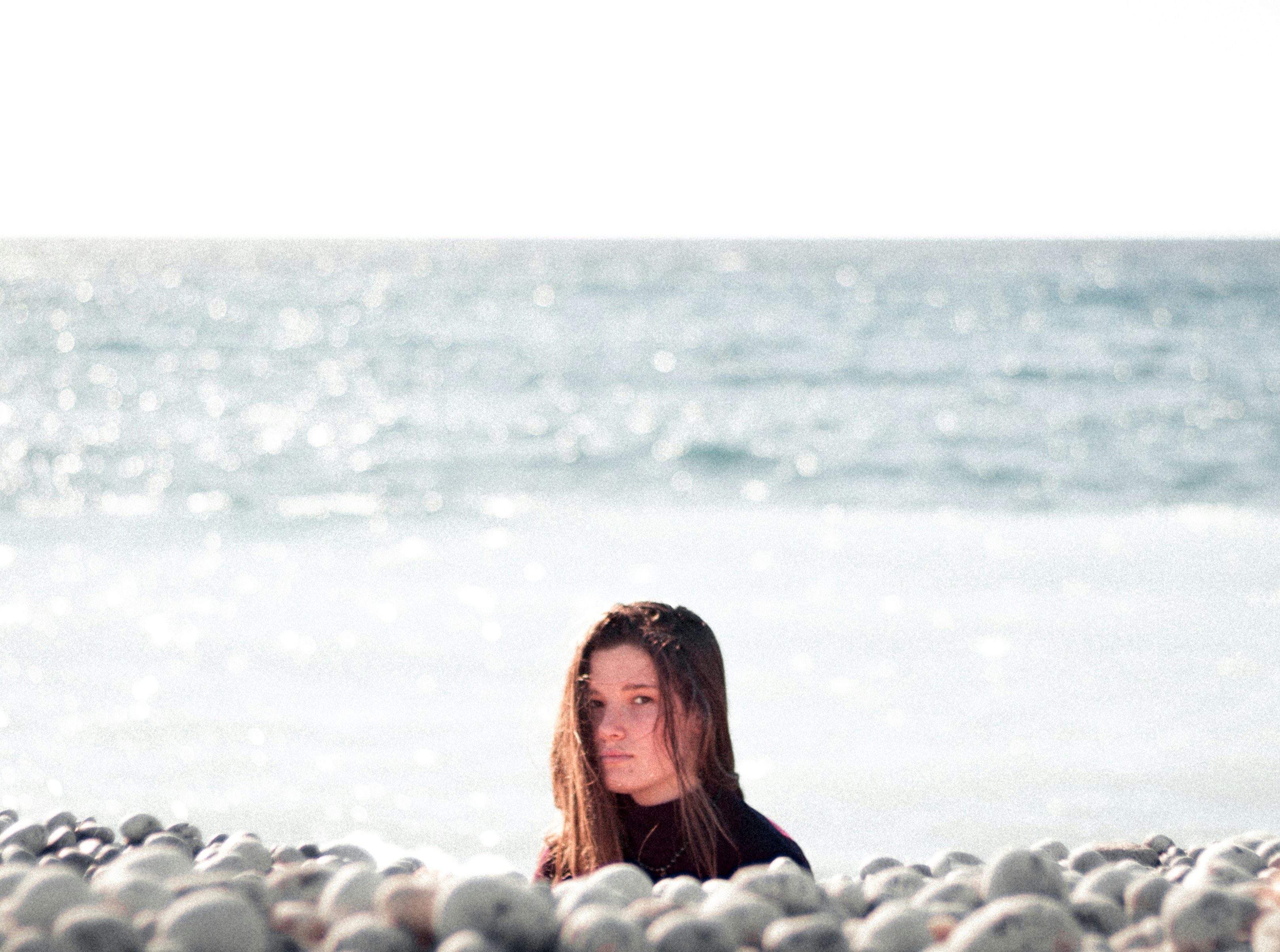 Pebble Beach Portrait: Quiet Gaze by the Sea
