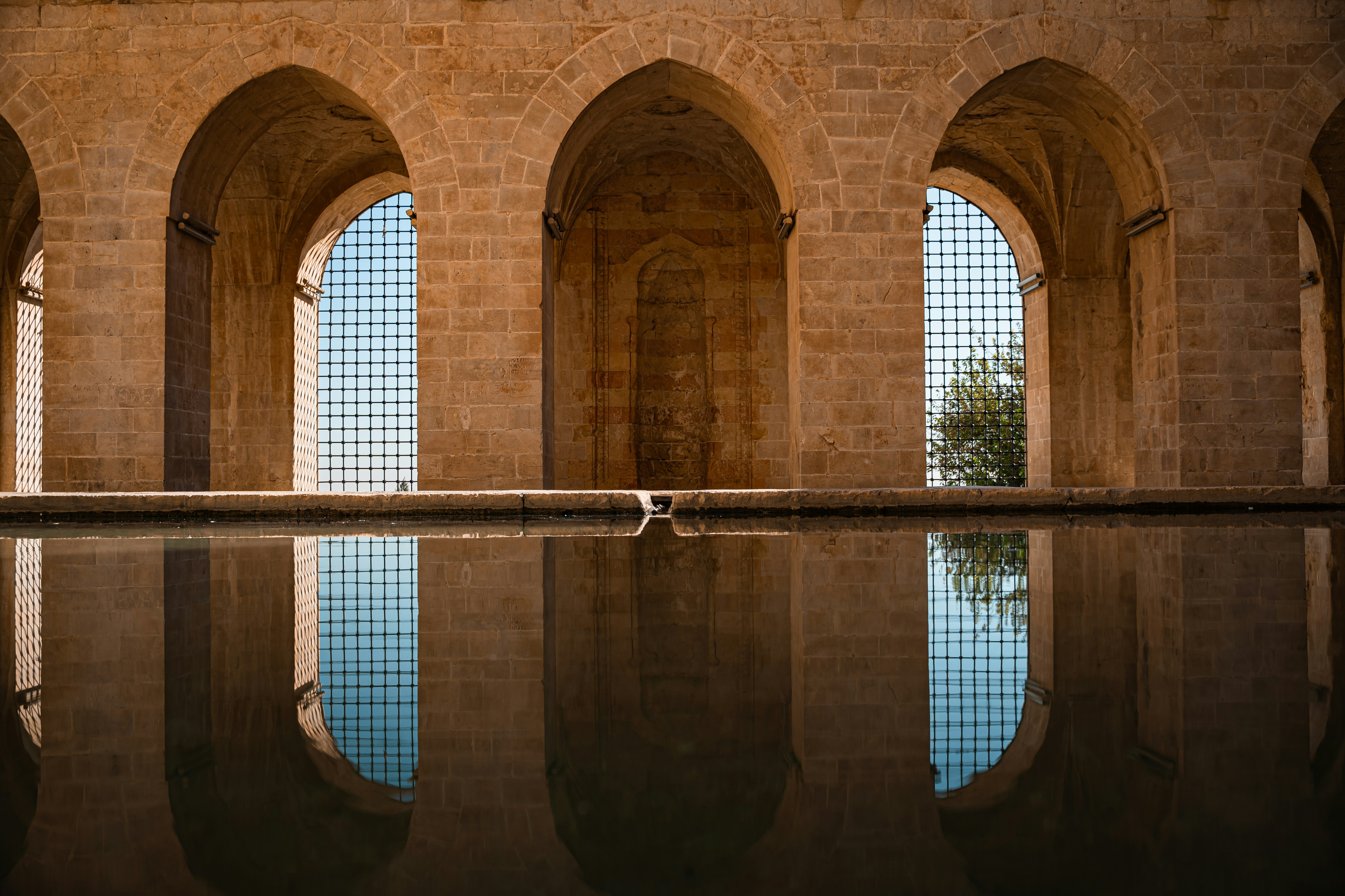 Symmetry in Stone: A Quiet Pool Beneath Arched Windows