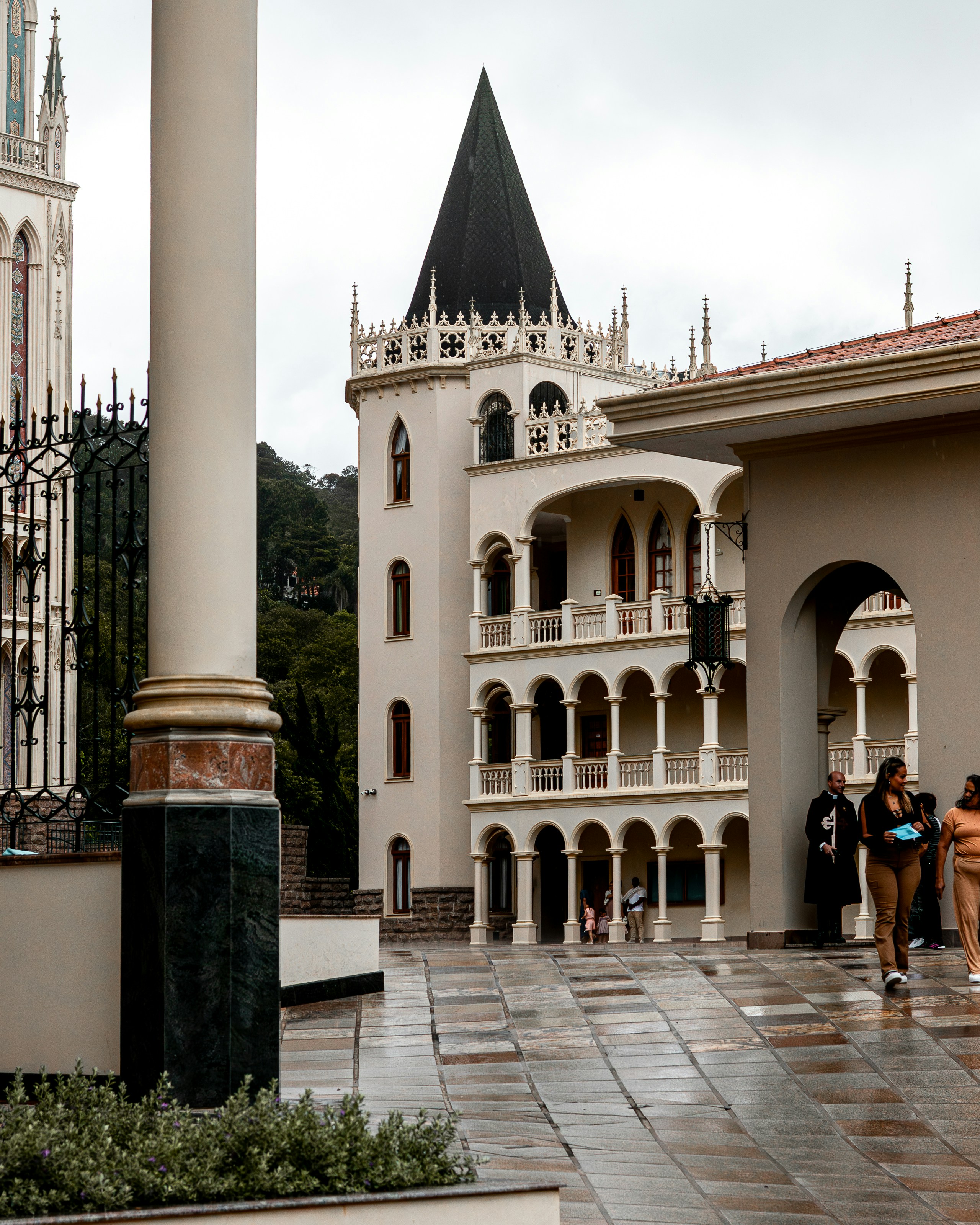 Turkish-inspired pavilion and ivy-topped spire loom over a sunlit courtyard