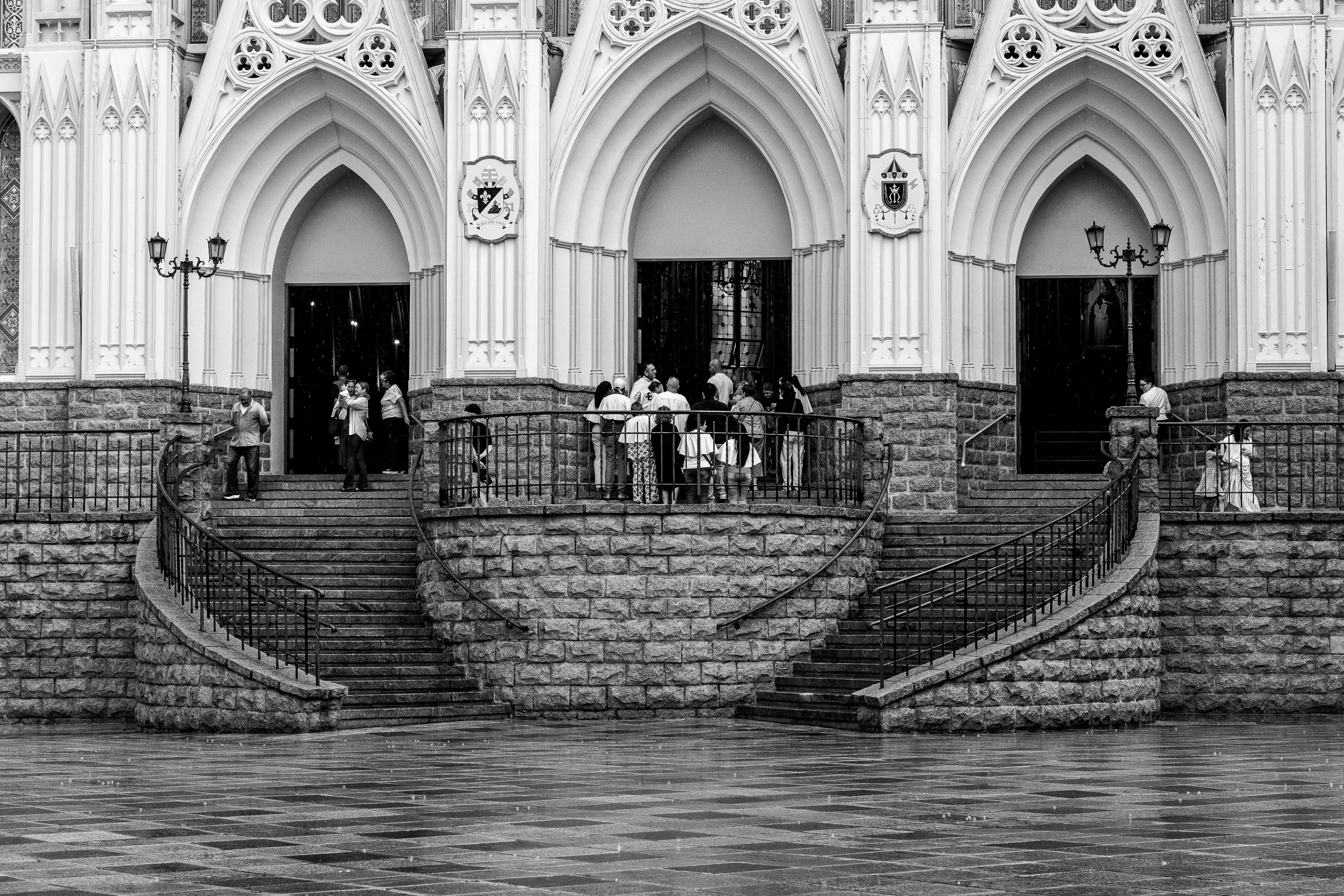 Staircase to a Gothic facade: a crowd at the church entrance
