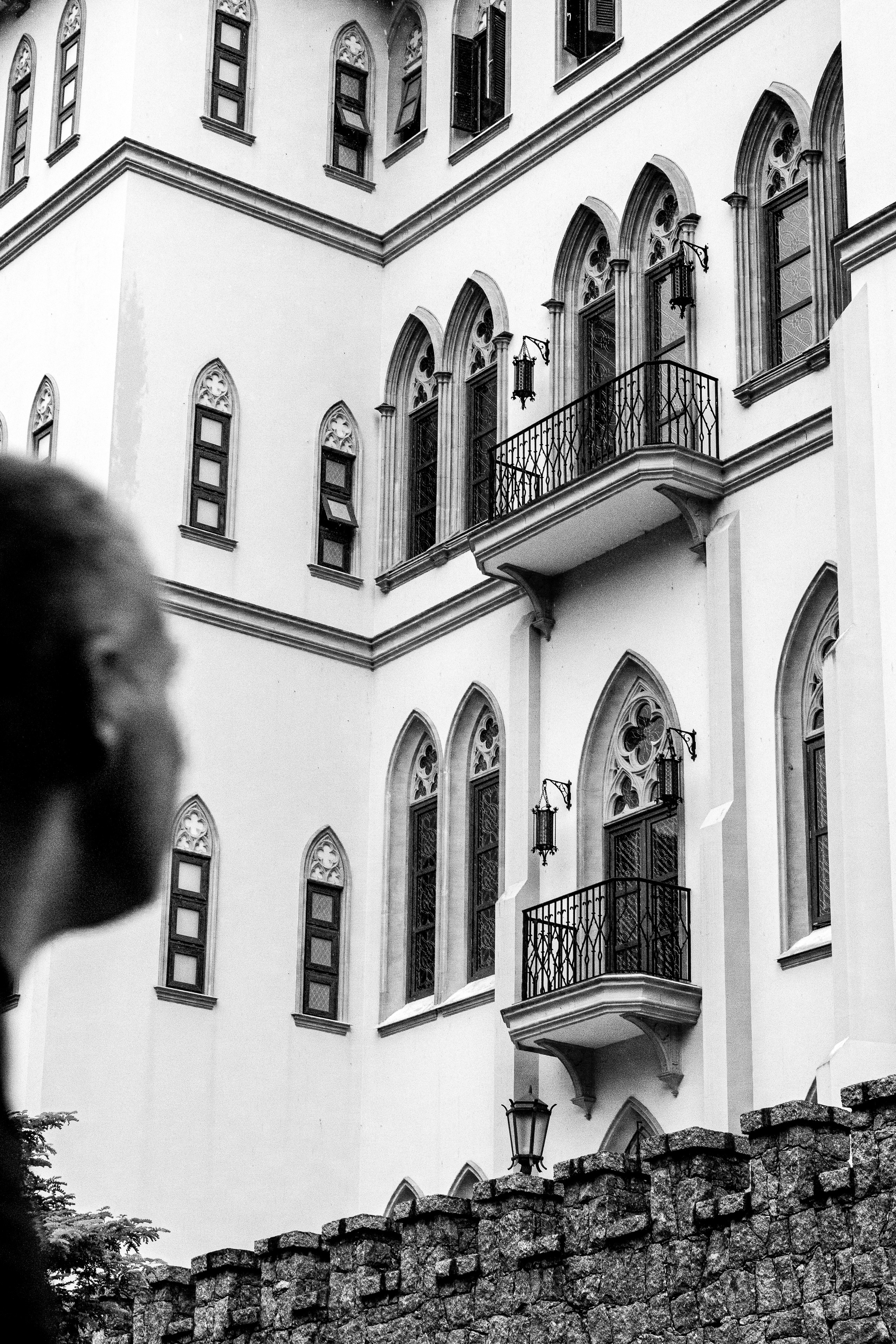 Overlooked Facade: A Crop of Gothic Windows and Balcony