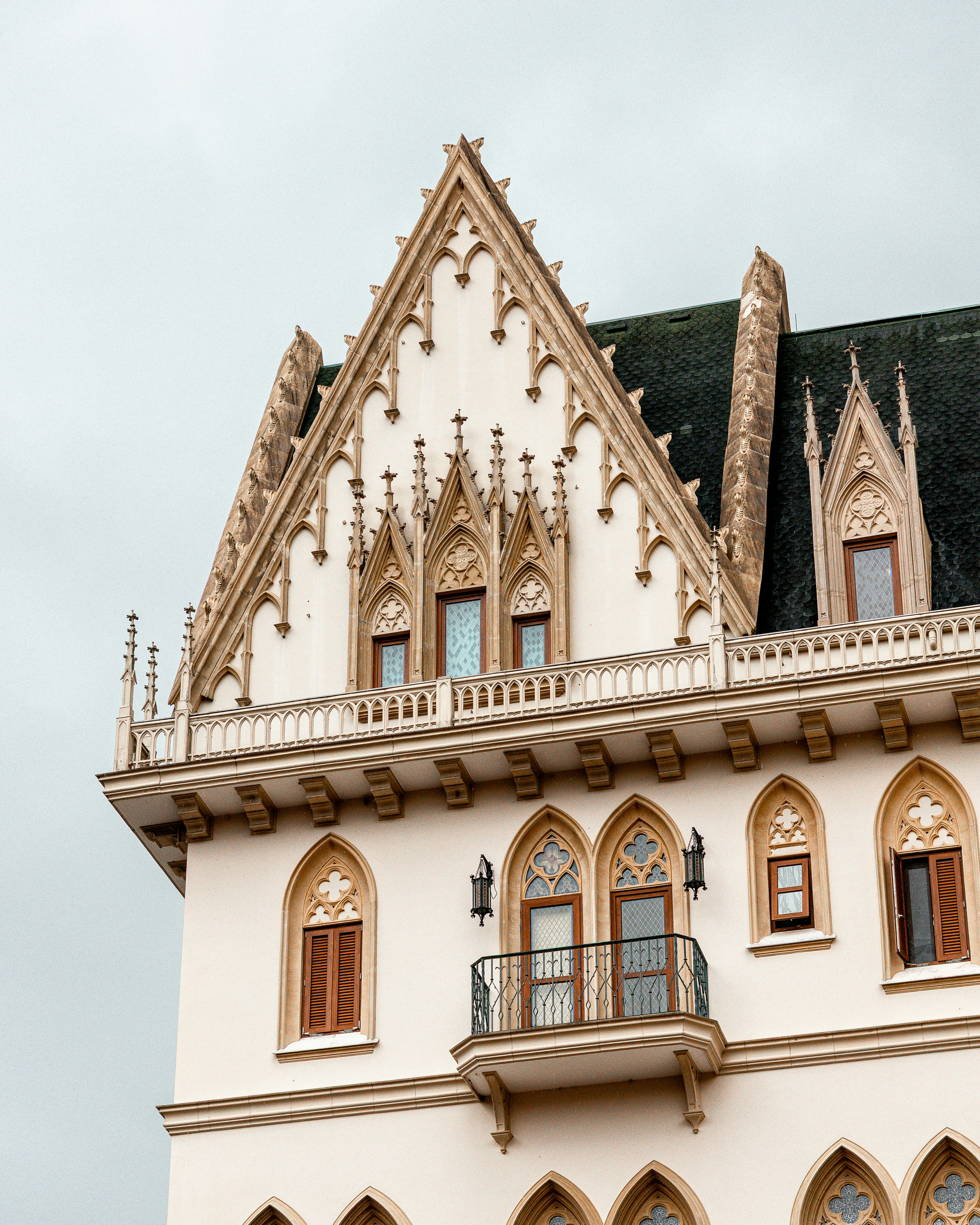 Gothic Revival Facade: Ornate Roofline and Balcony Details