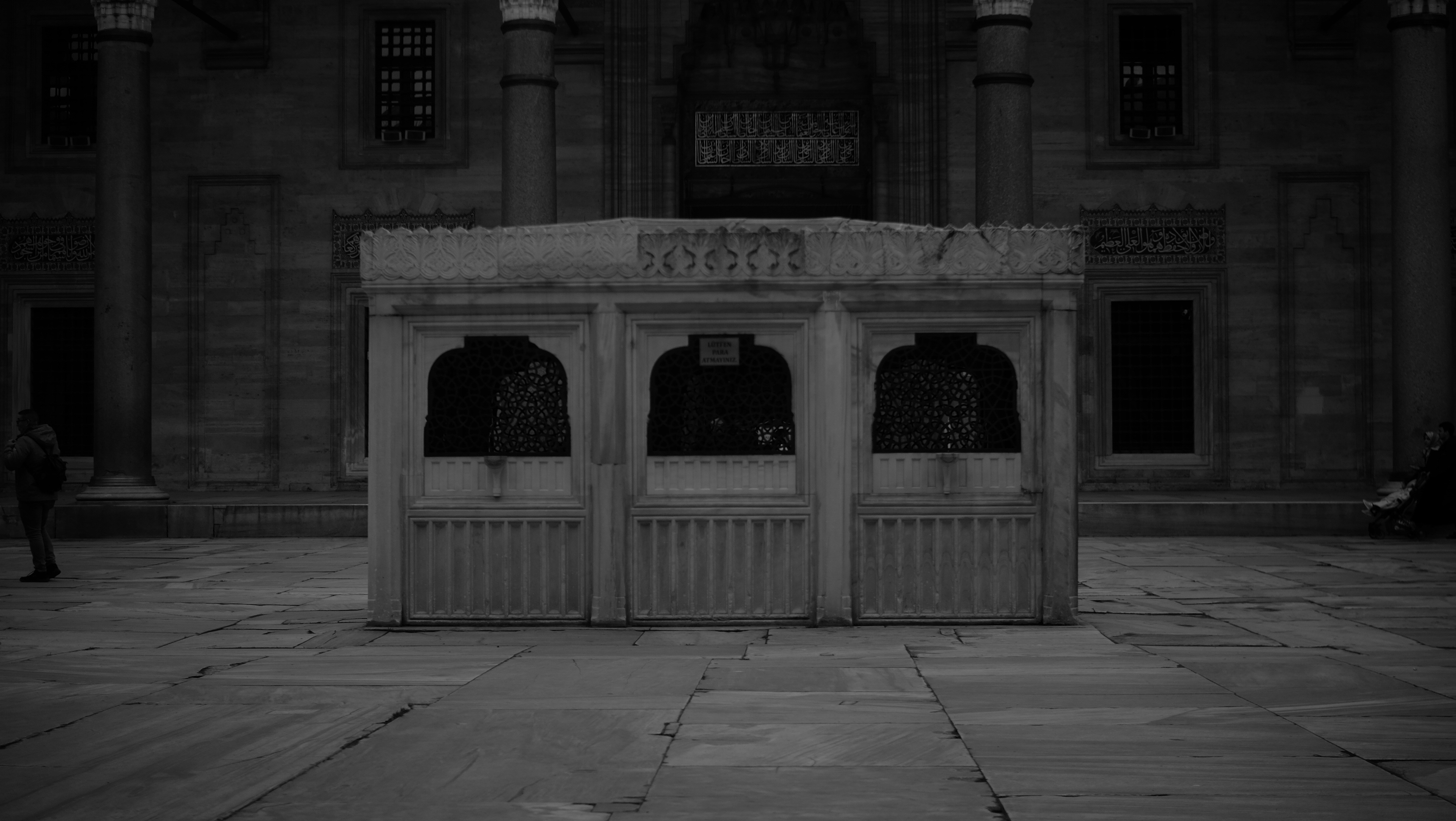 Quiet Shrine: A Stone Kiosk Framed by Silent Architecture