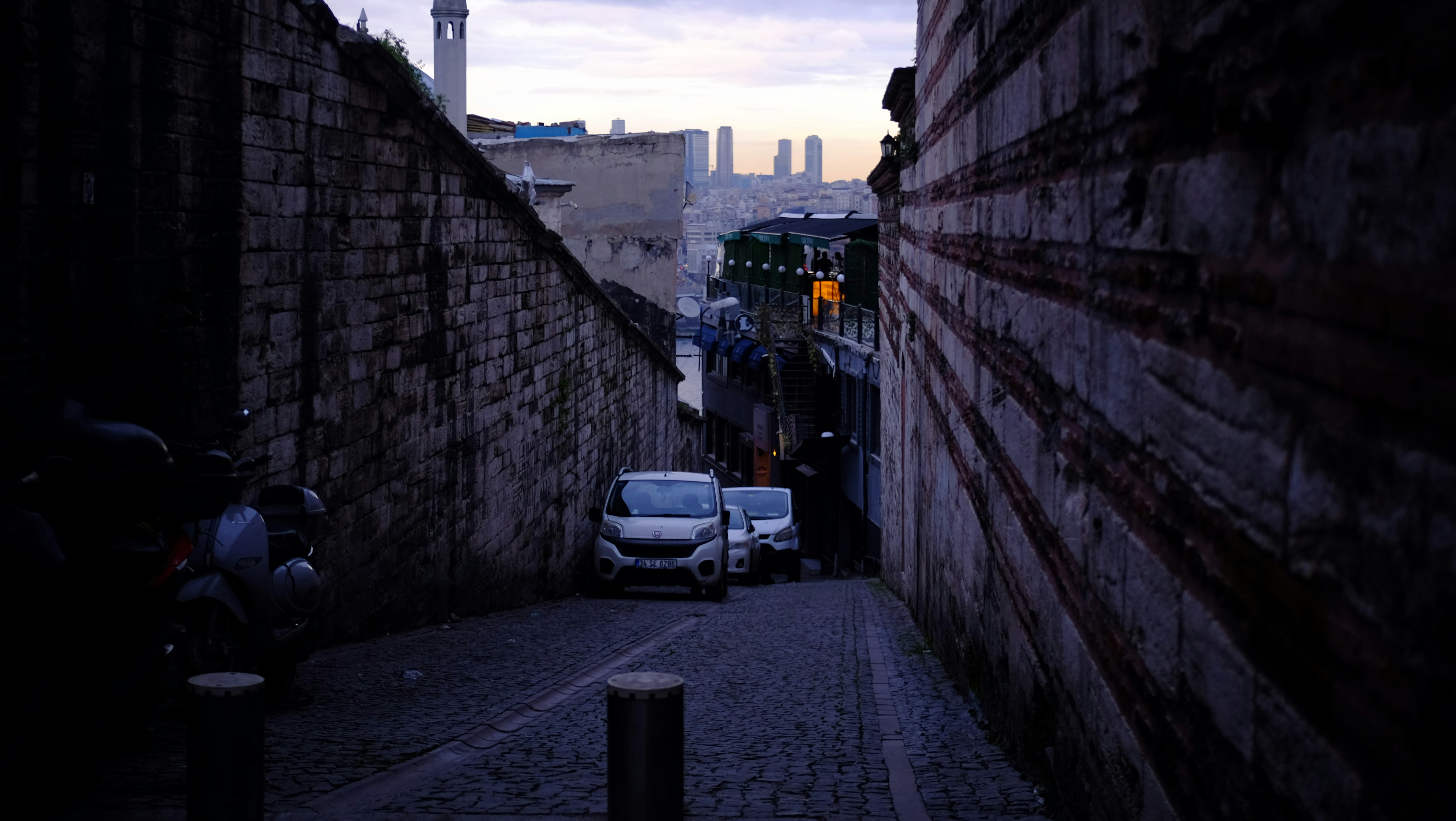 Cobbled Descent Toward a Distant Cityscape