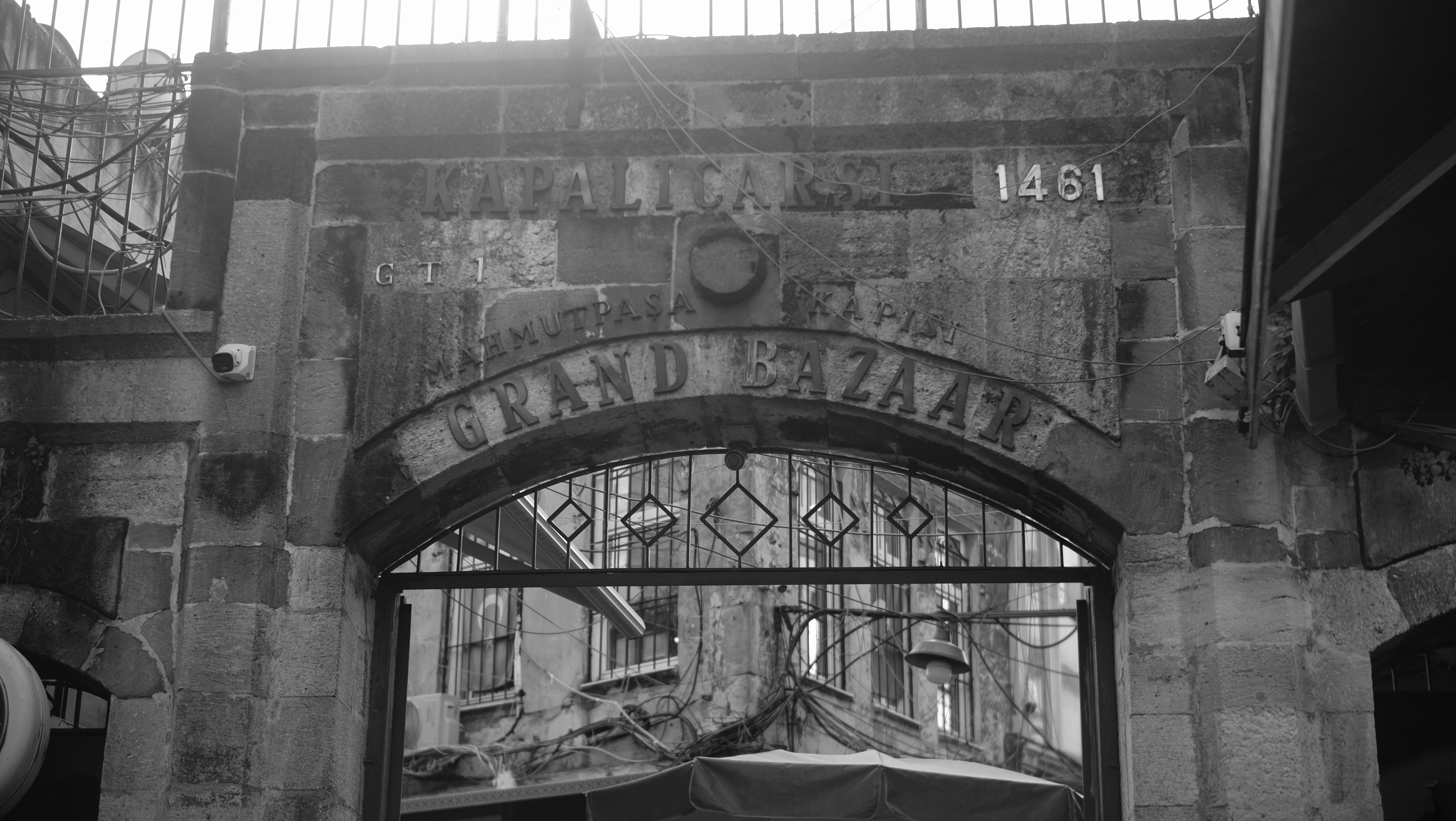 Gate of Grand Bazaar: Weathered Arch Welcoming a Distant Market Street