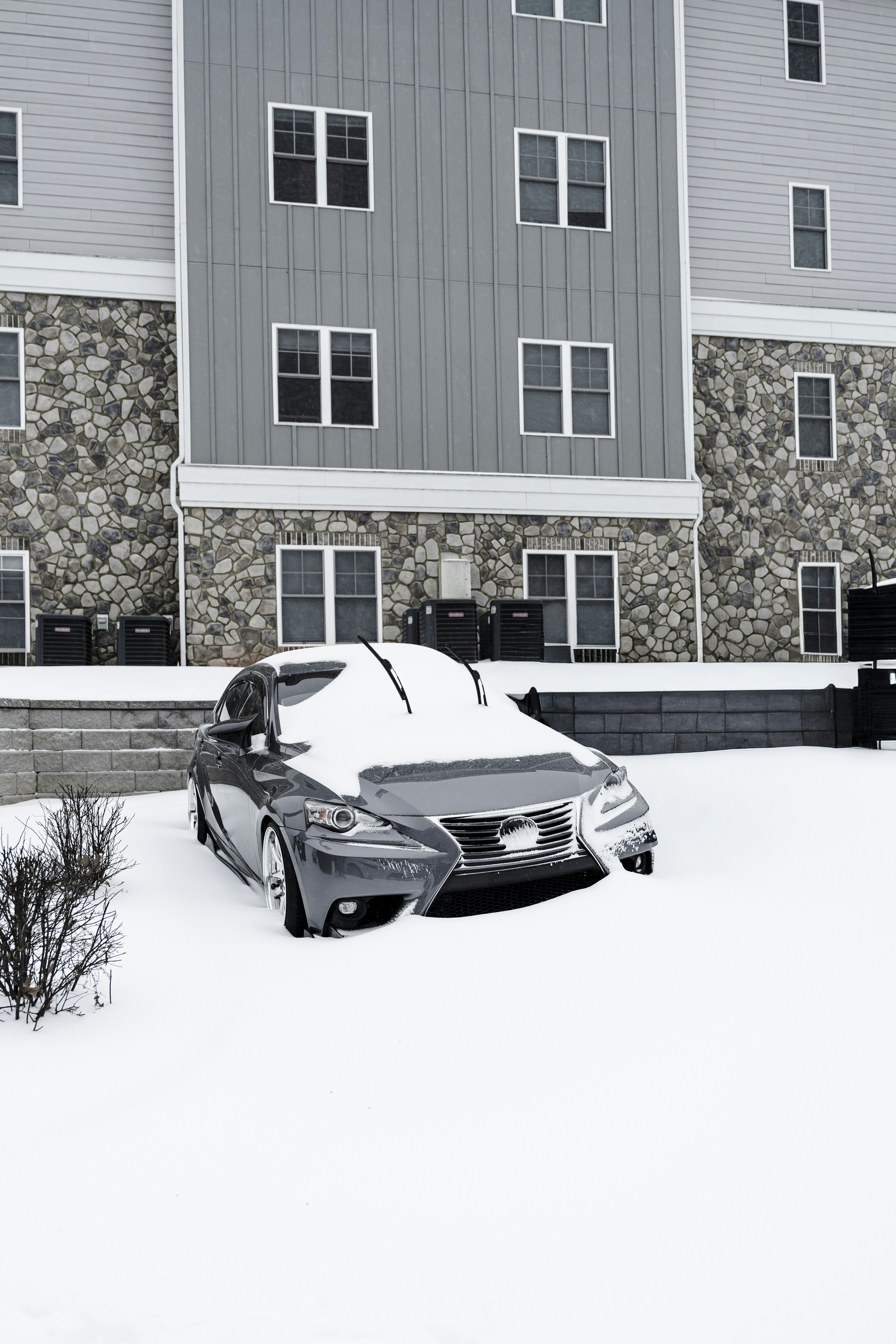 Snowbound Sedan in a Stone-and-Siding Courtyard