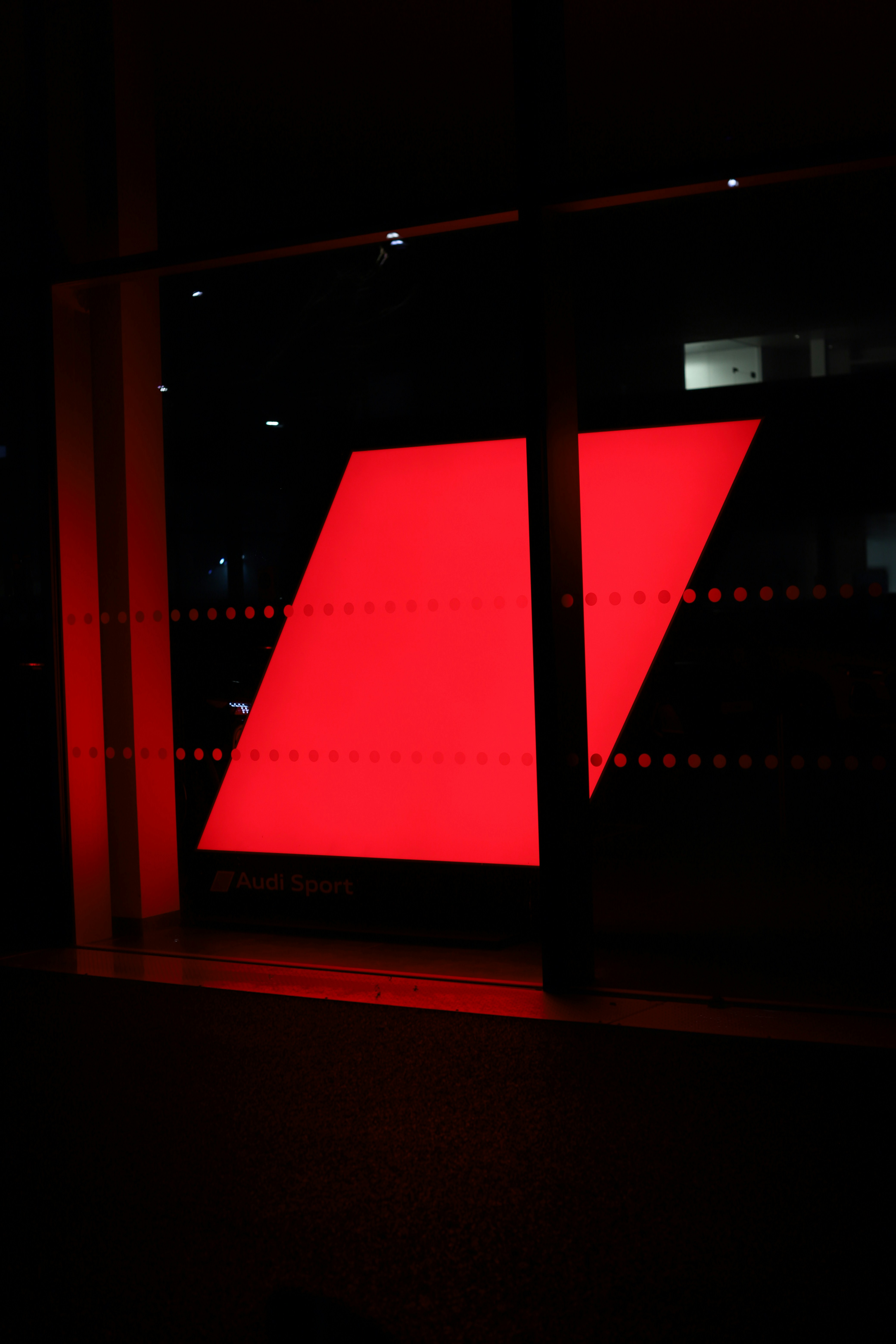 Crimson Geometry at Night: Red Glass Panels in a Dark Gallery