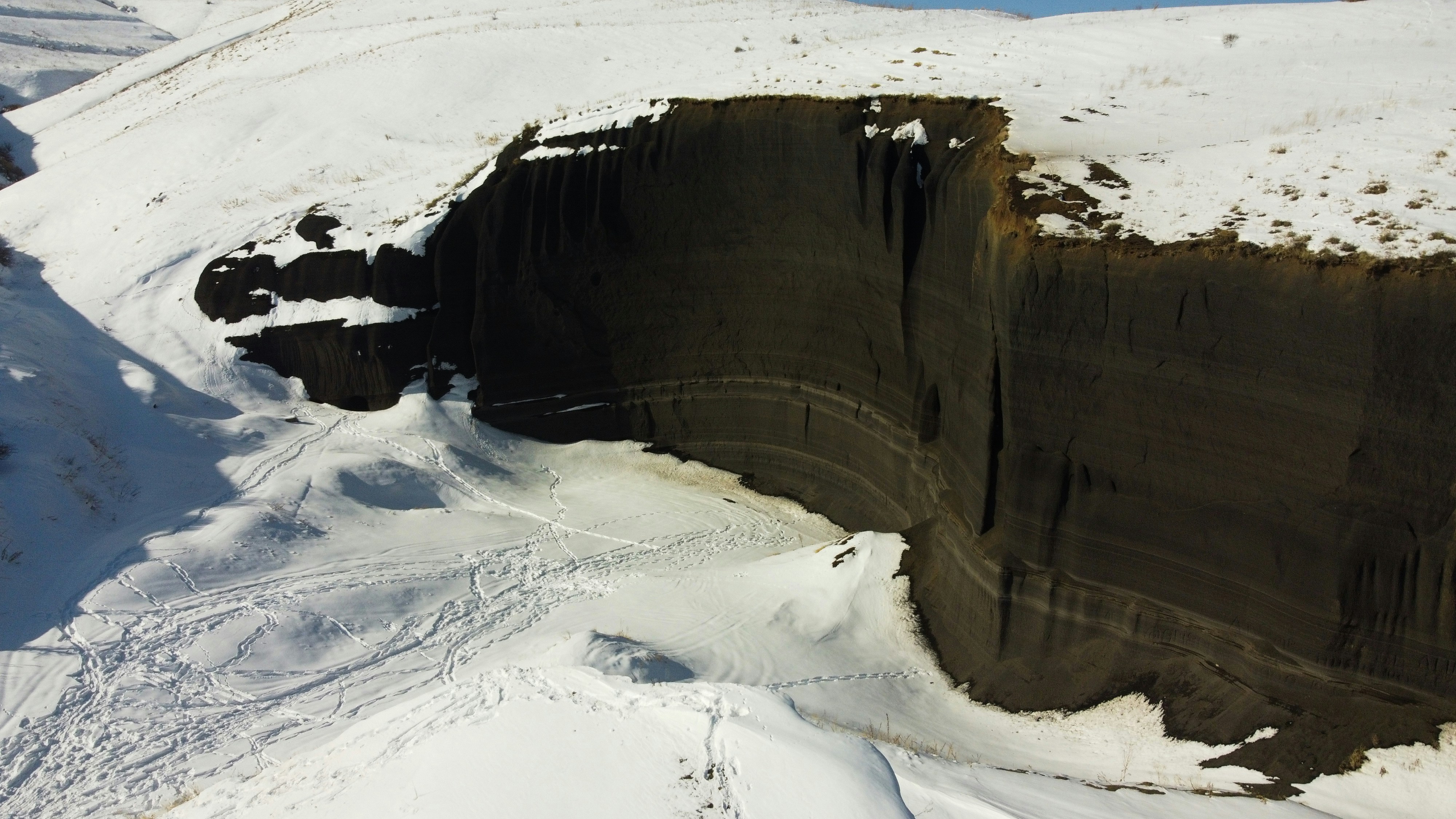 Snowbound Cliff Edge: Striated Shadow and Ice Smoothness
