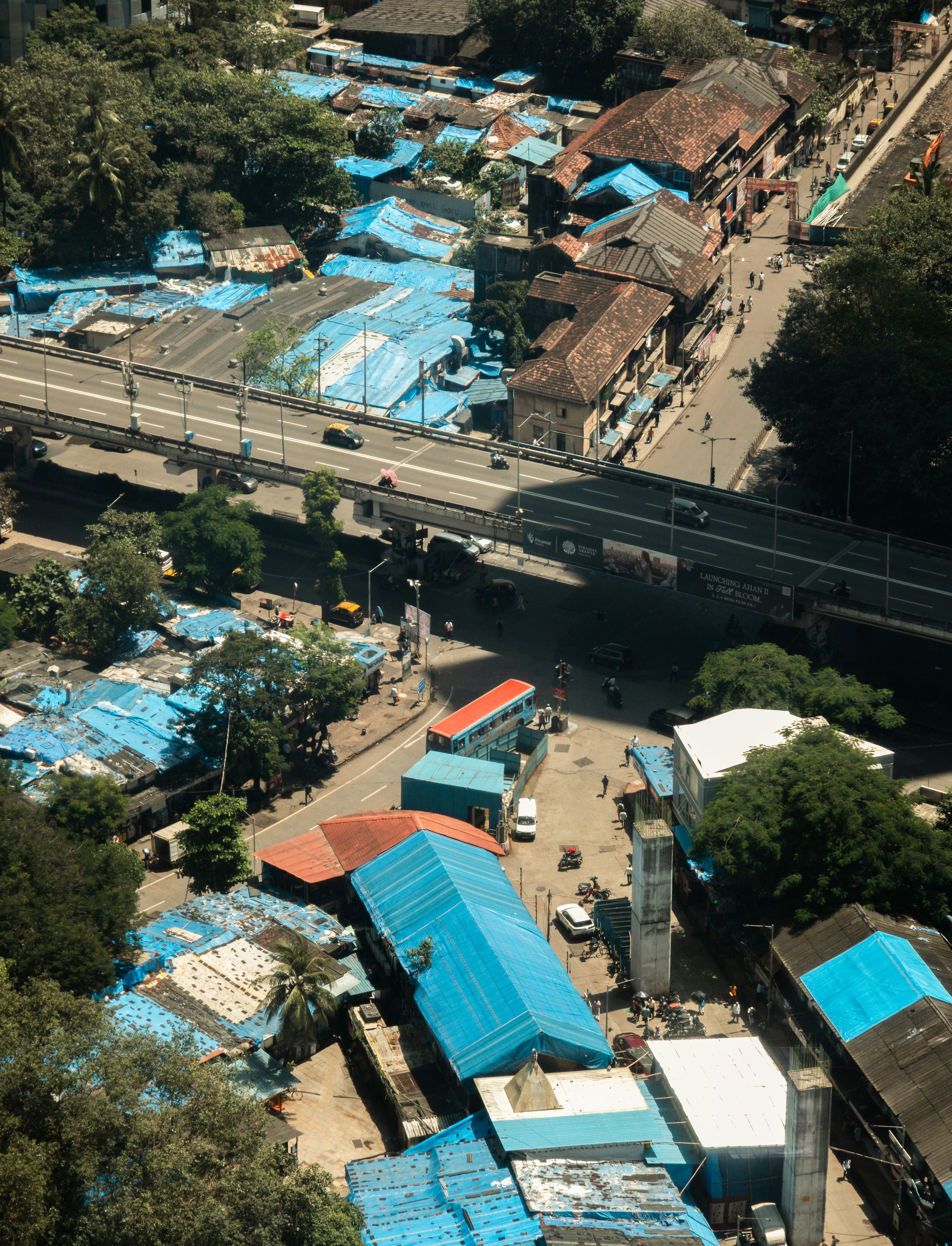 Blue Canopy Alley: An Aerial Ramble Over a Busy Market District