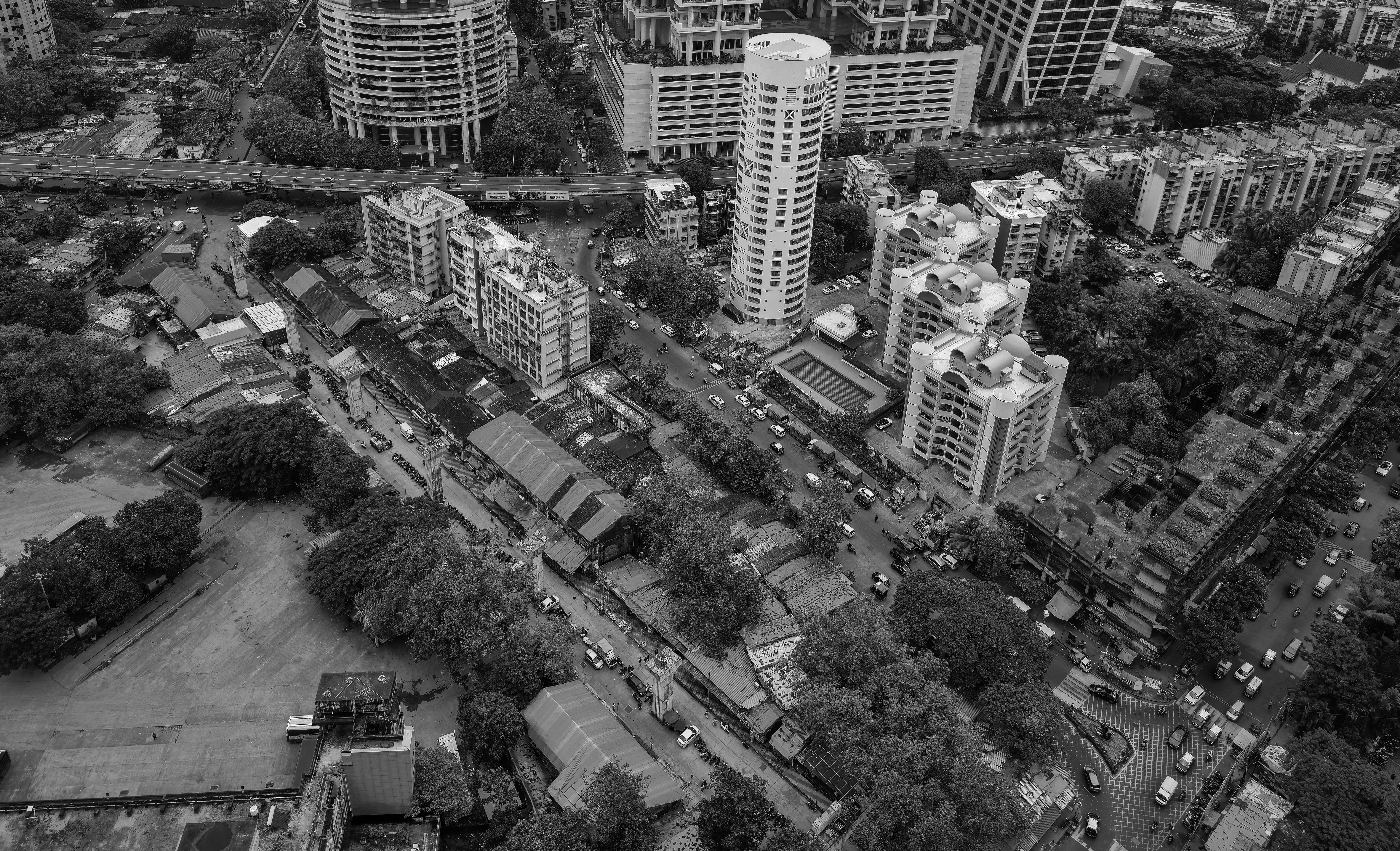 Aerial grayscale snapshot of a mid-density urban corridor