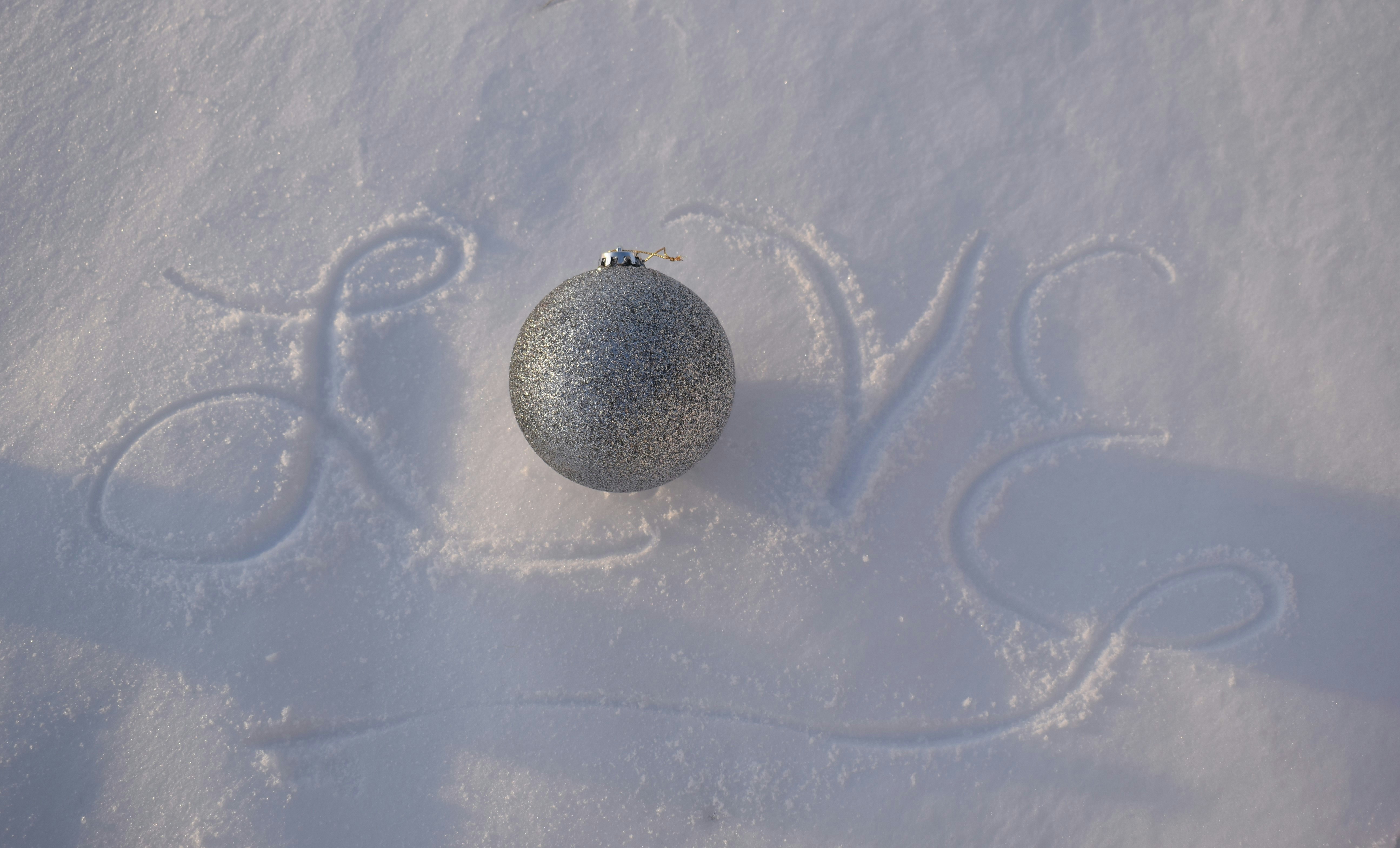 Glittering Ornament Centered in Snow Script