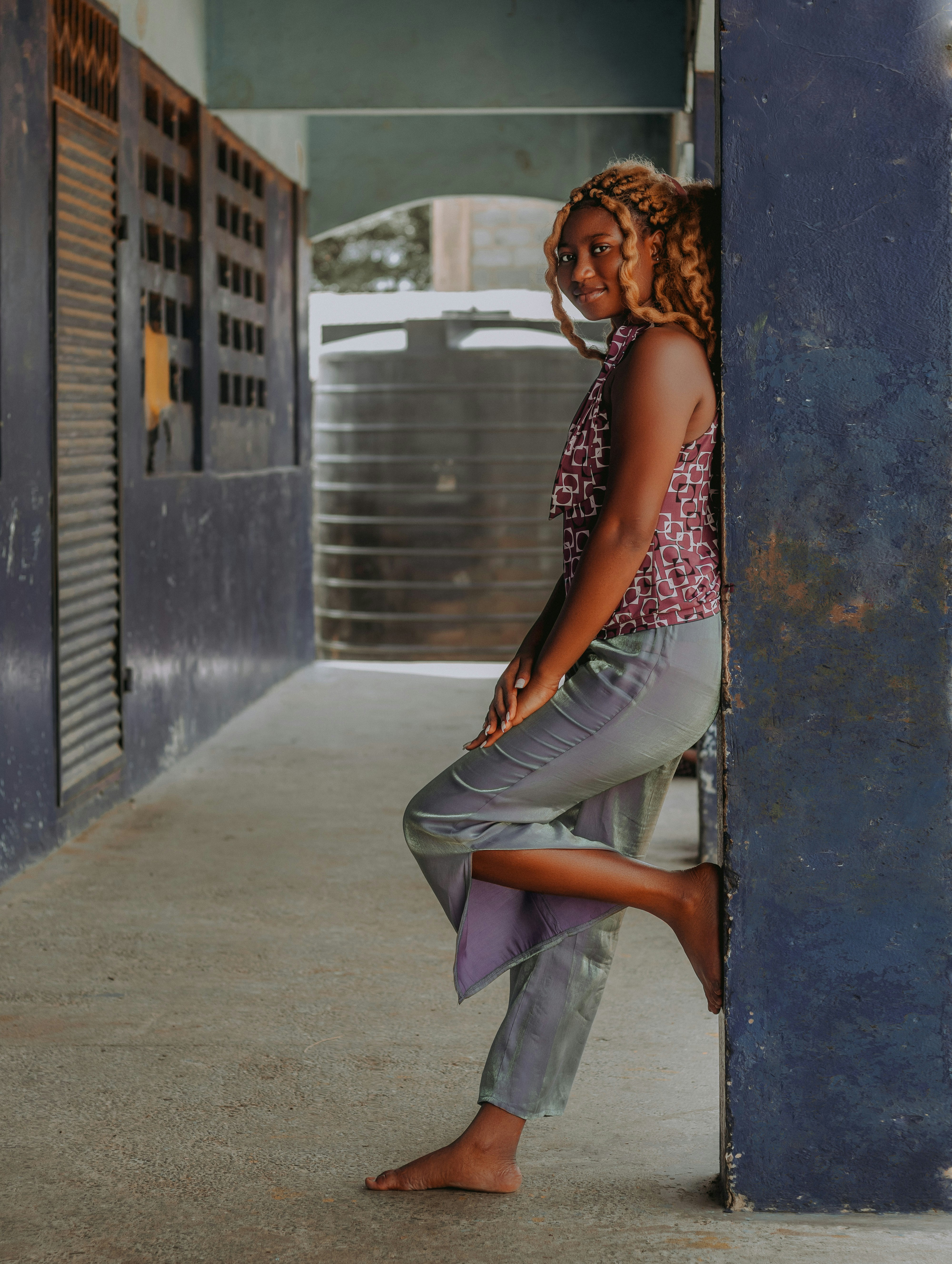 Grace in the Corridor: A Quiet Poise by the Blue Wall