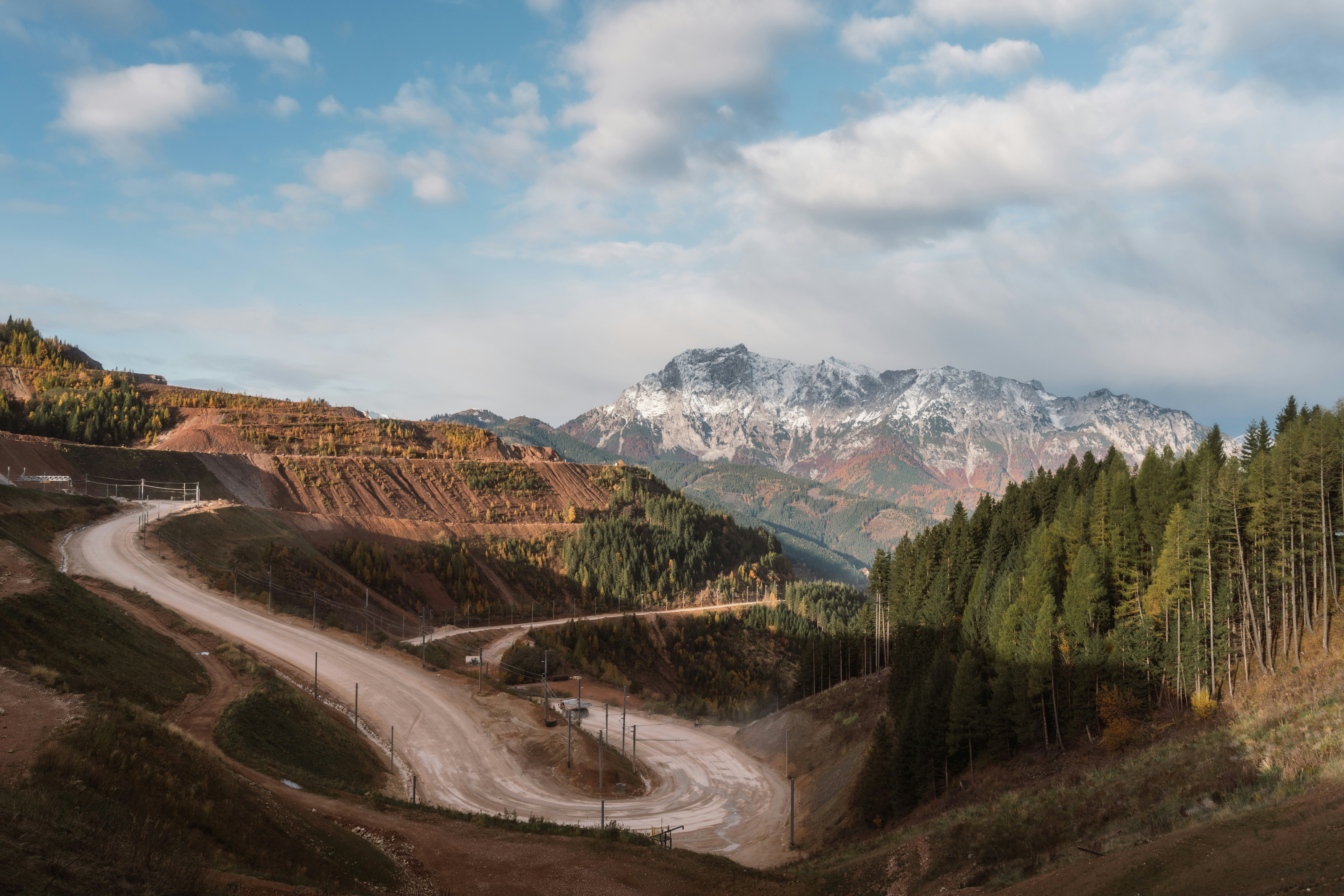 Dusty switchbacks toward snow-capped peaks